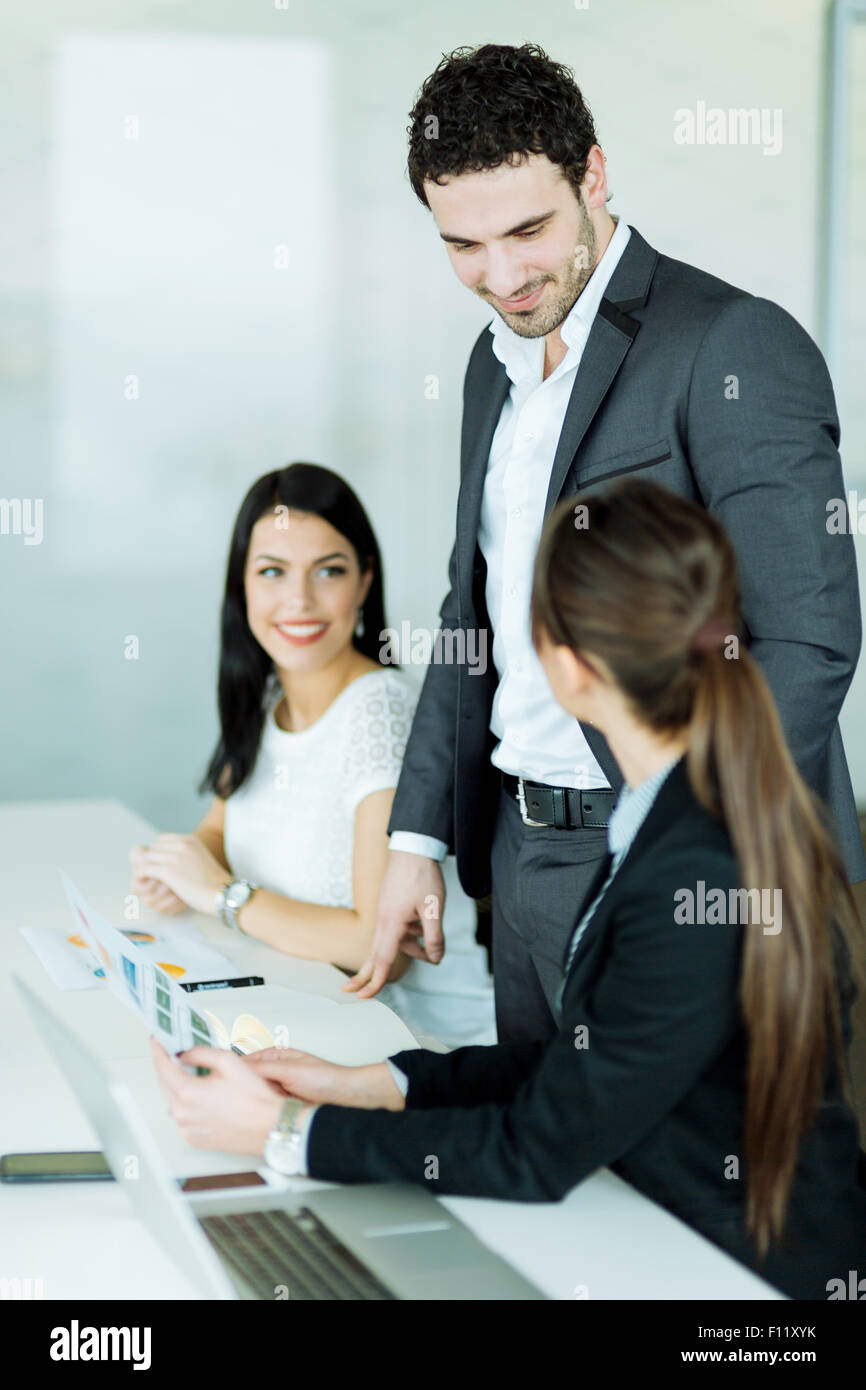 Boss checking up on his secretaries and consulting Stock Photo - Alamy