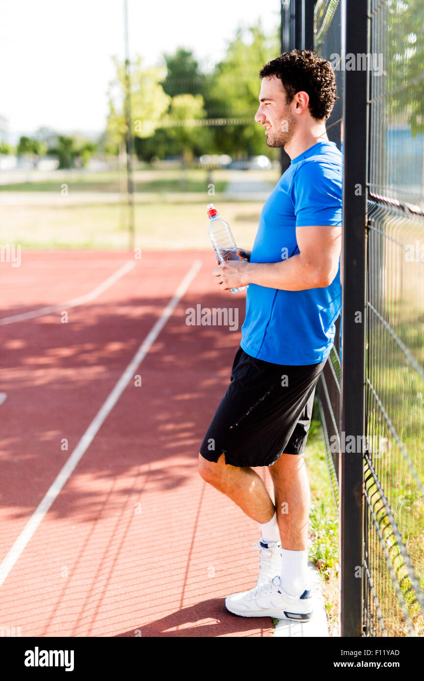 Young athlete taking a break from exercising on a hot summer day Stock ...