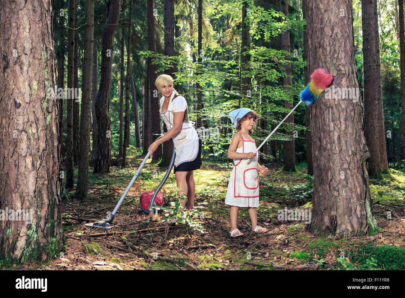 symbolic picture with mother and daughter by cleaning of the forest ...