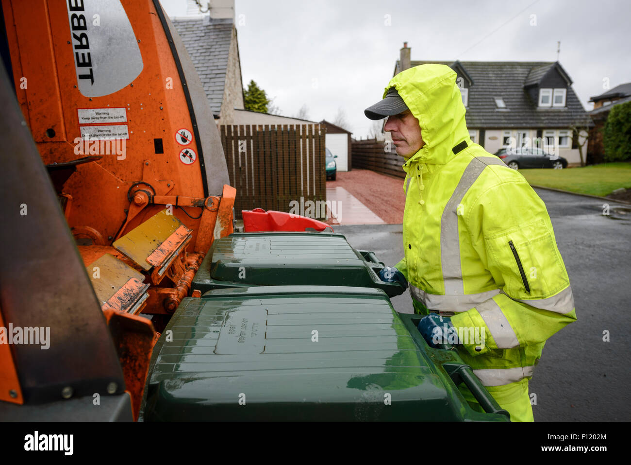 Bin men on thier refuse collection round in a small town in Scotland ...
