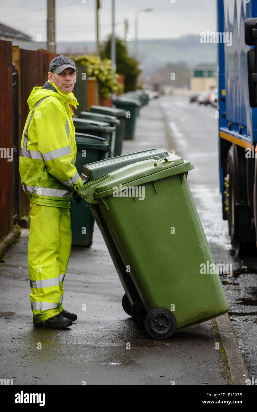 Bin men on thier refuse collection round in a small town in Scotland ...