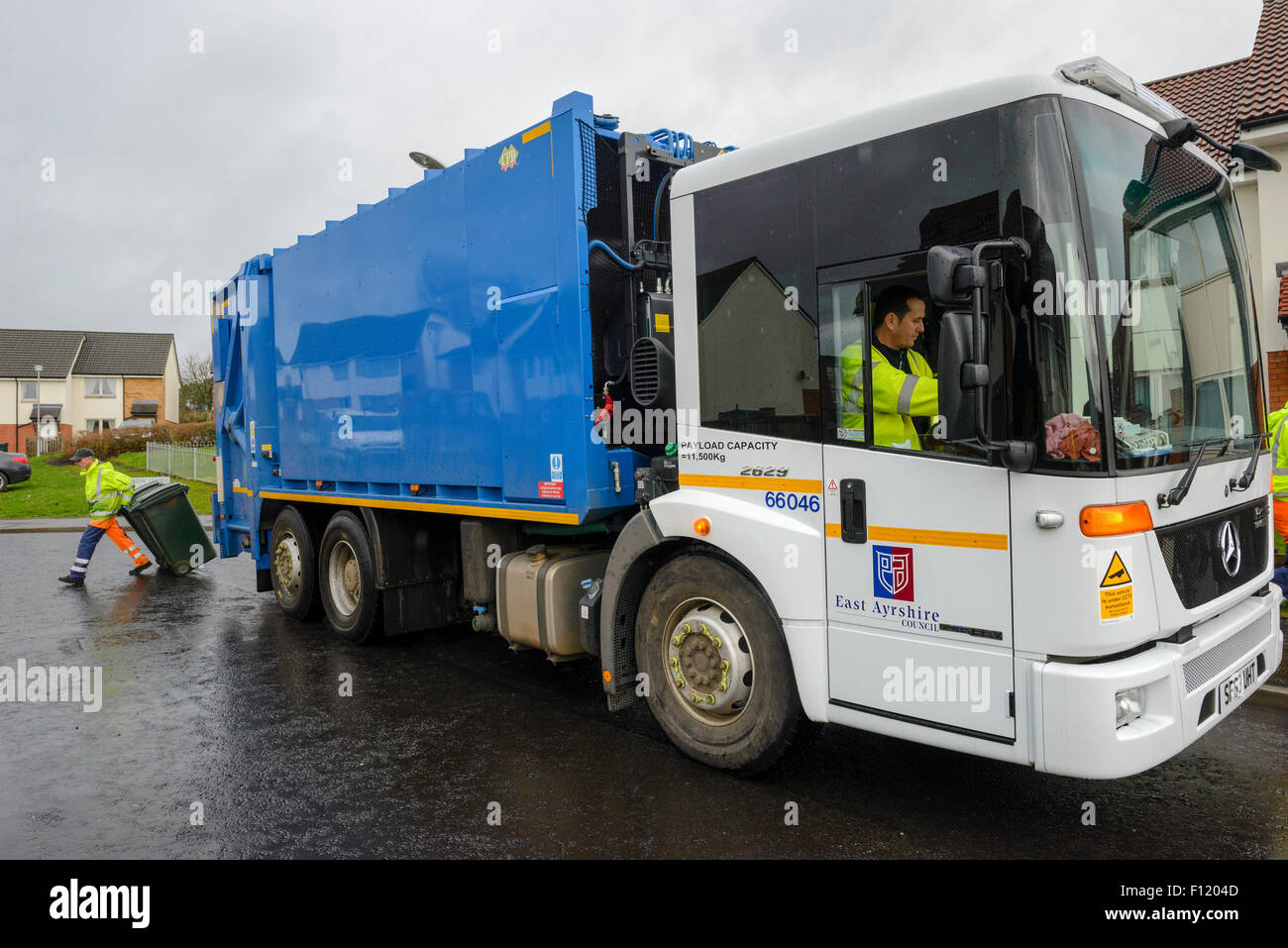 Bin men on thier refuse collection round in a small town in Scotland ...