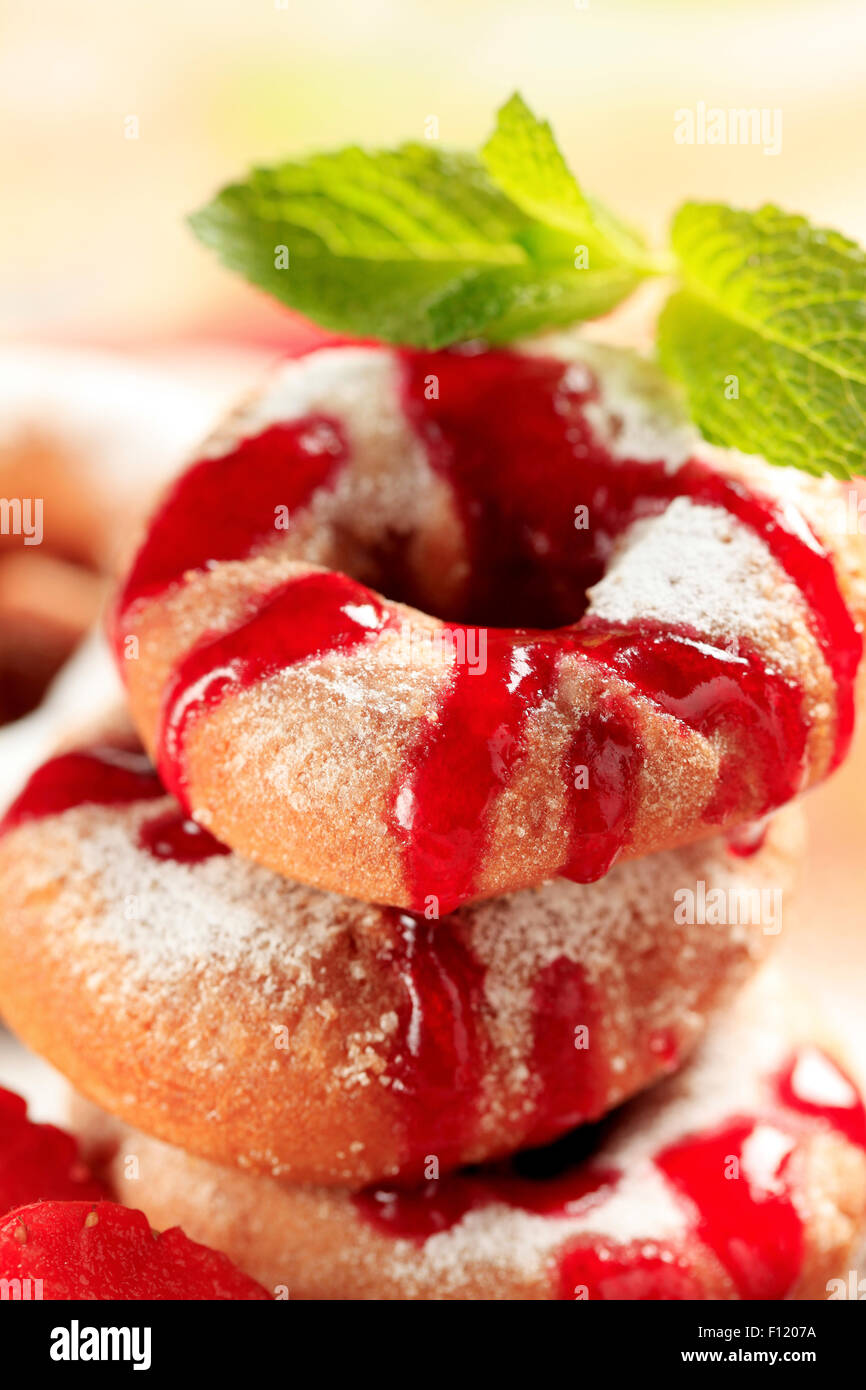 Ring donuts with strawberry syrup Stock Photo - Alamy