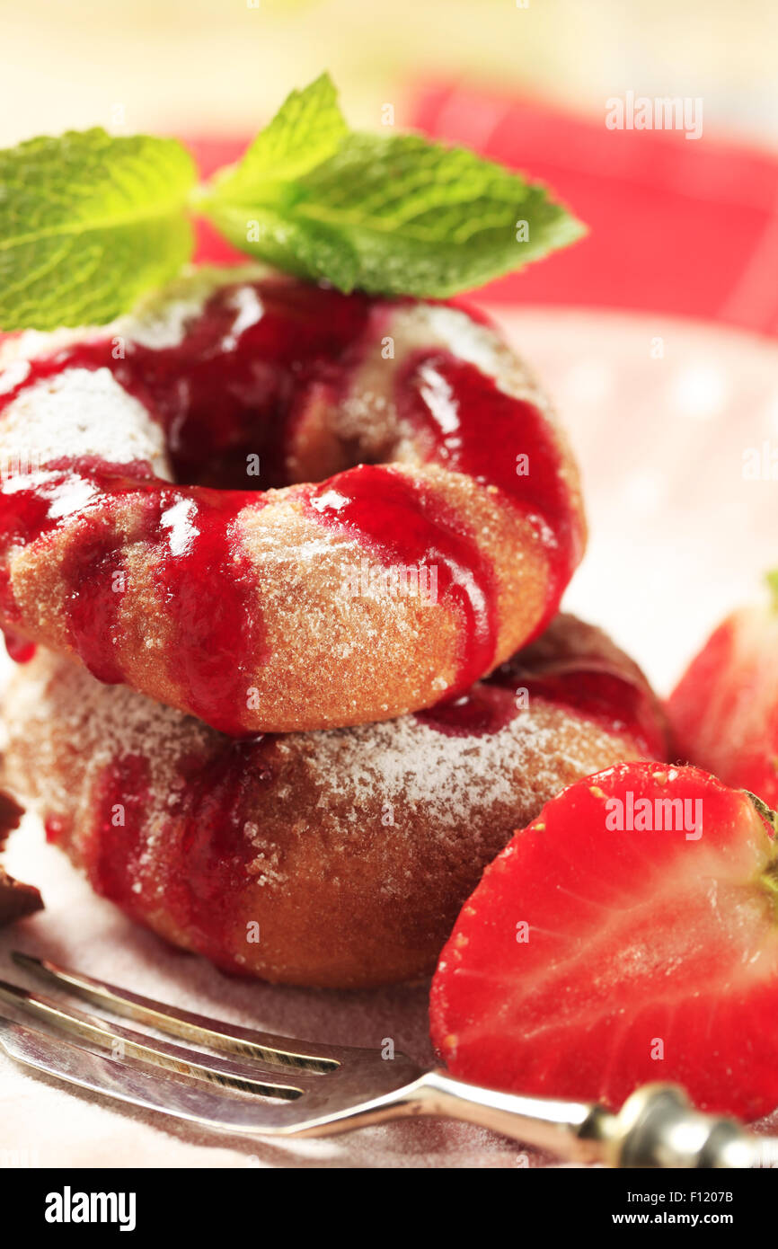 Ring donuts with strawberry syrup Stock Photo - Alamy