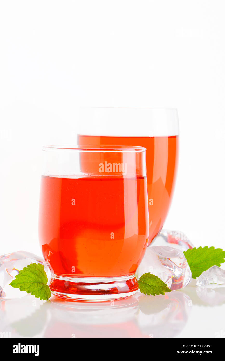 two glasses of fruit flavored drinks on white background Stock Photo ...