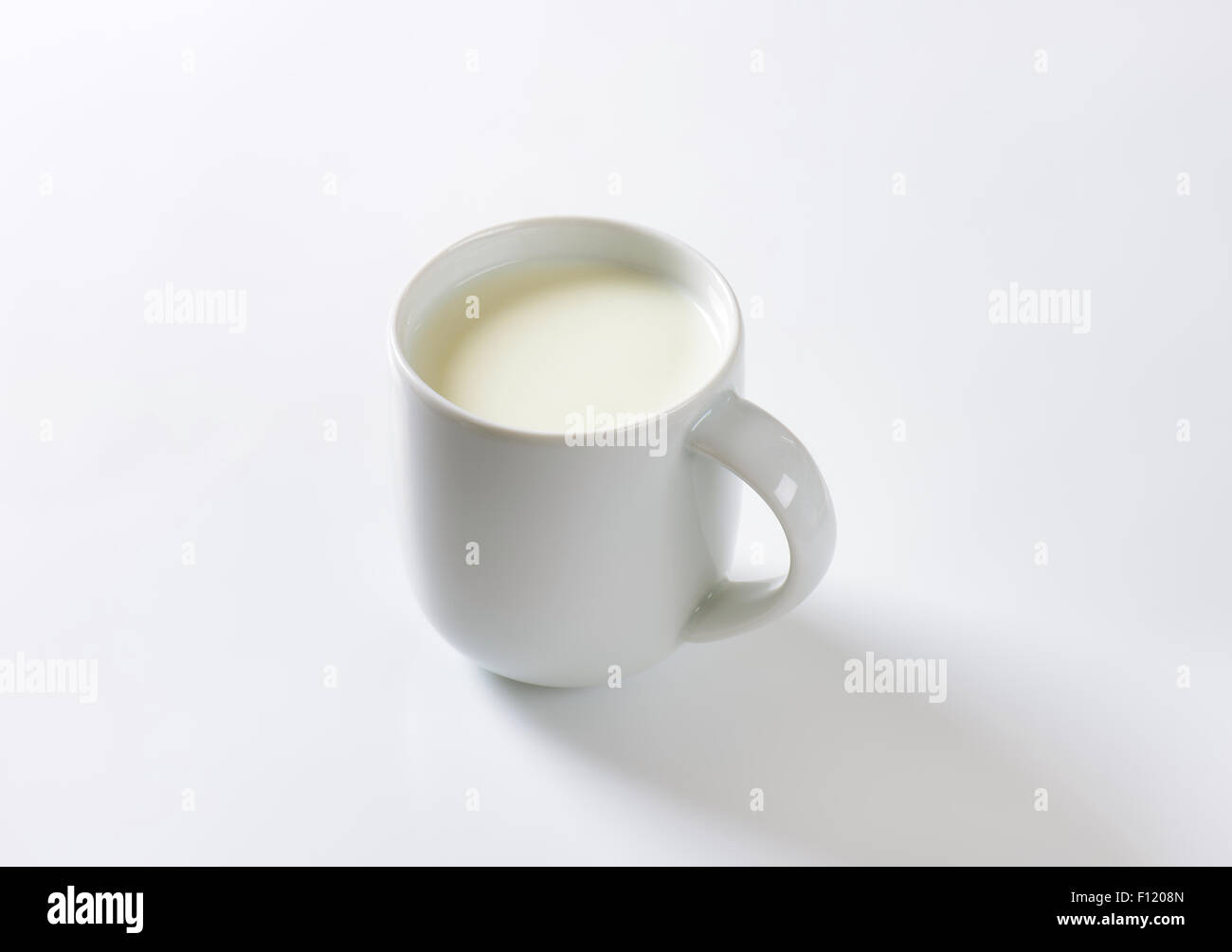 mug of milk on white background Stock Photo - Alamy