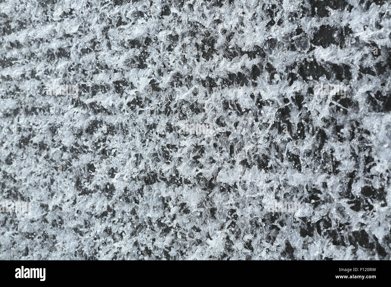 water falling over dark rock wall Stock Photo - Alamy