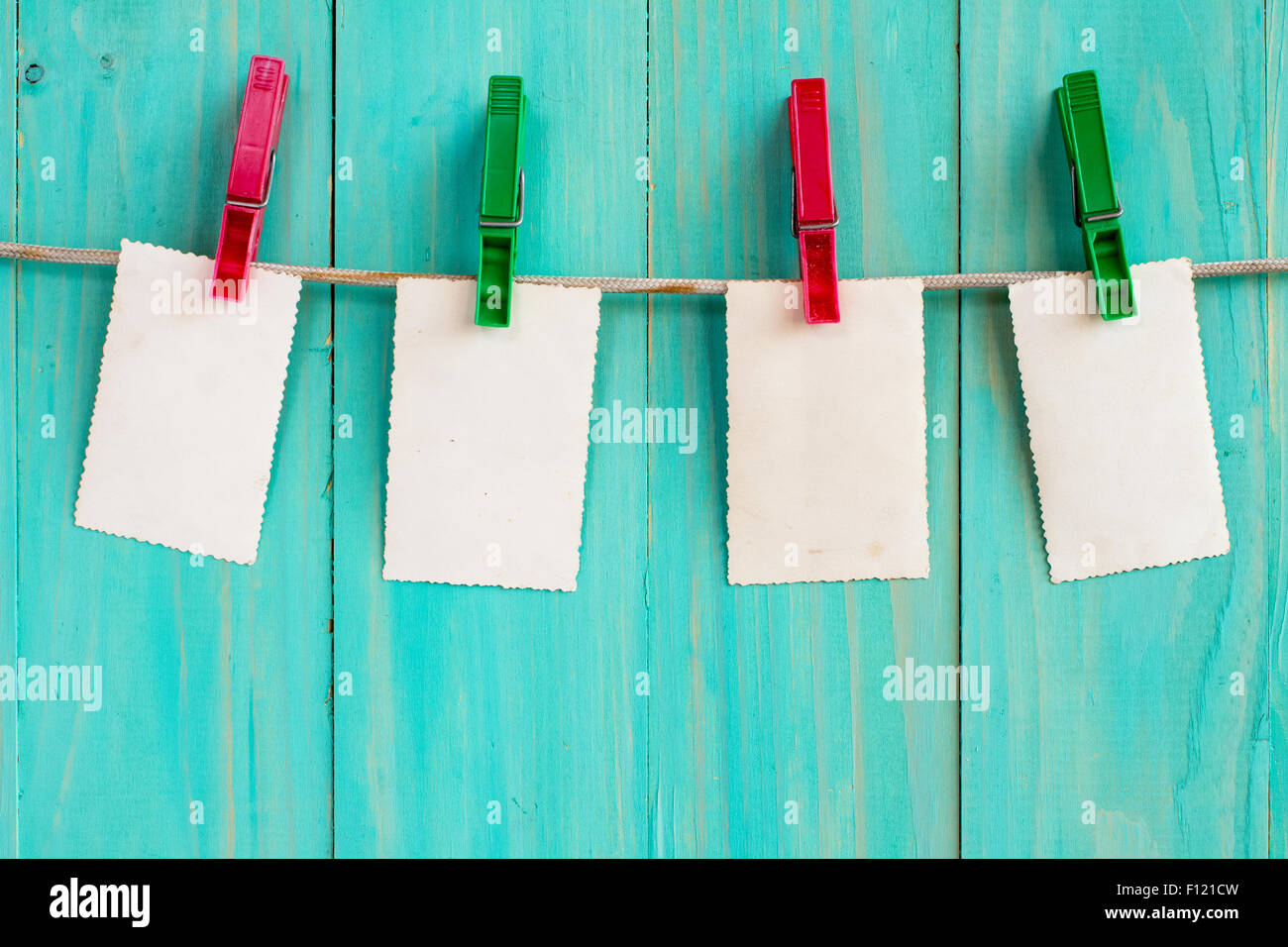 Photo frames hanging on a rope over blue wooden background Stock Photo ...