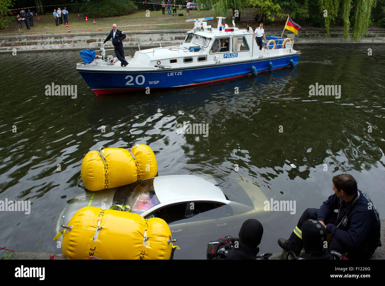 Berlin, Germany. 25th Aug, 2015. A police boat approaches a submerged ...