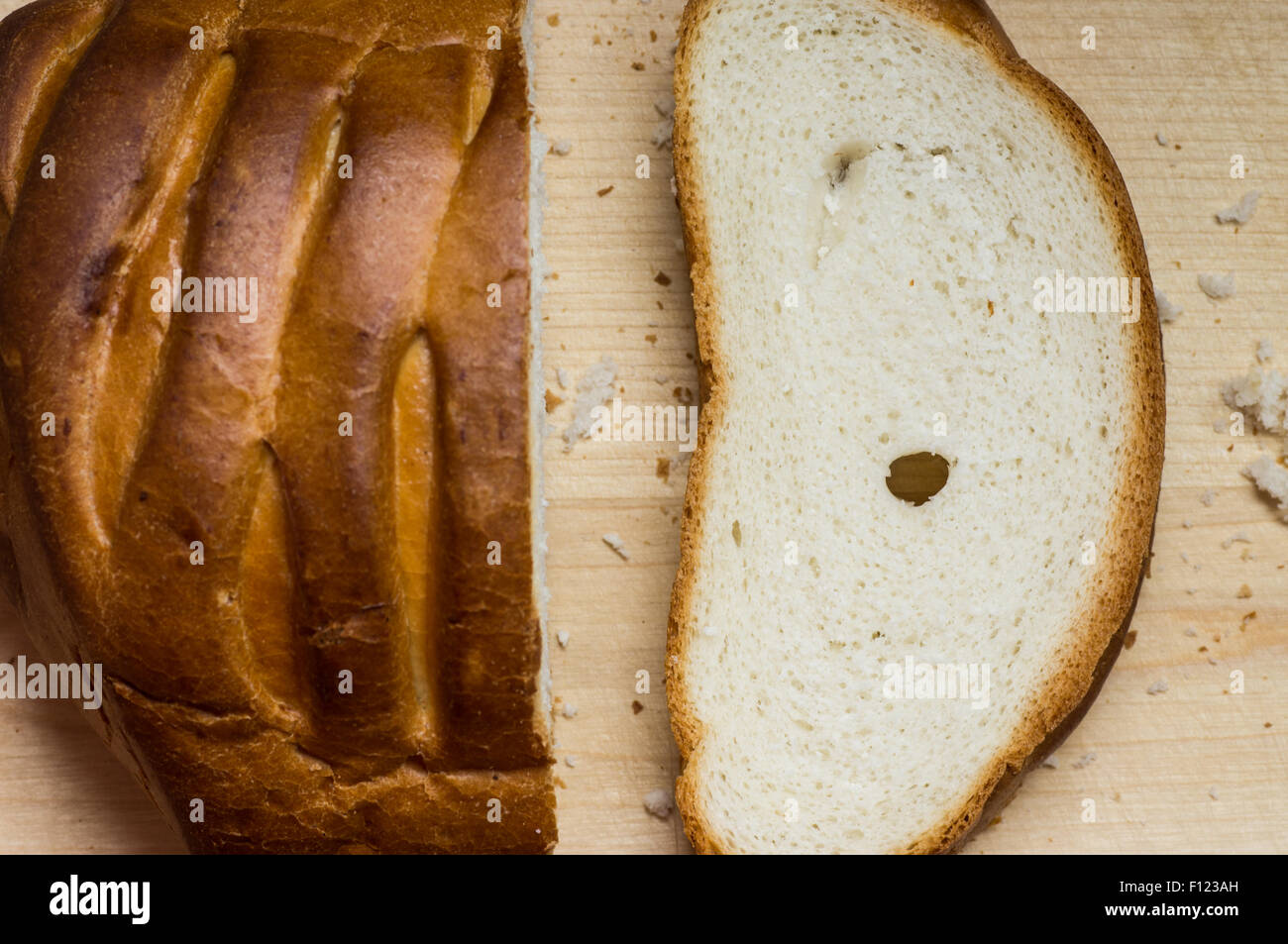 Cut off a piece of loaf bread top view Stock Photo - Alamy