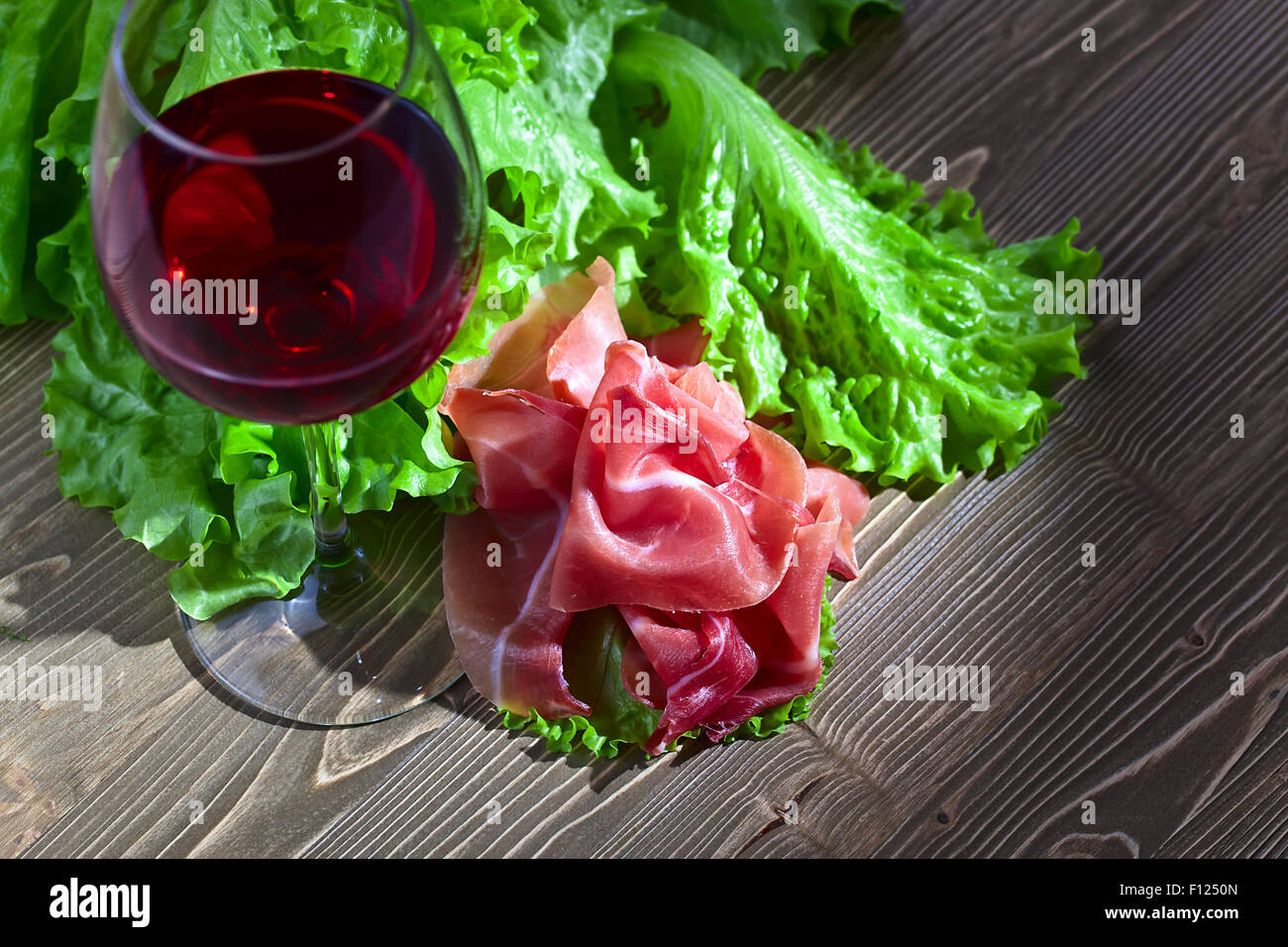 jamon and red wine on wooden table Stock Photo - Alamy