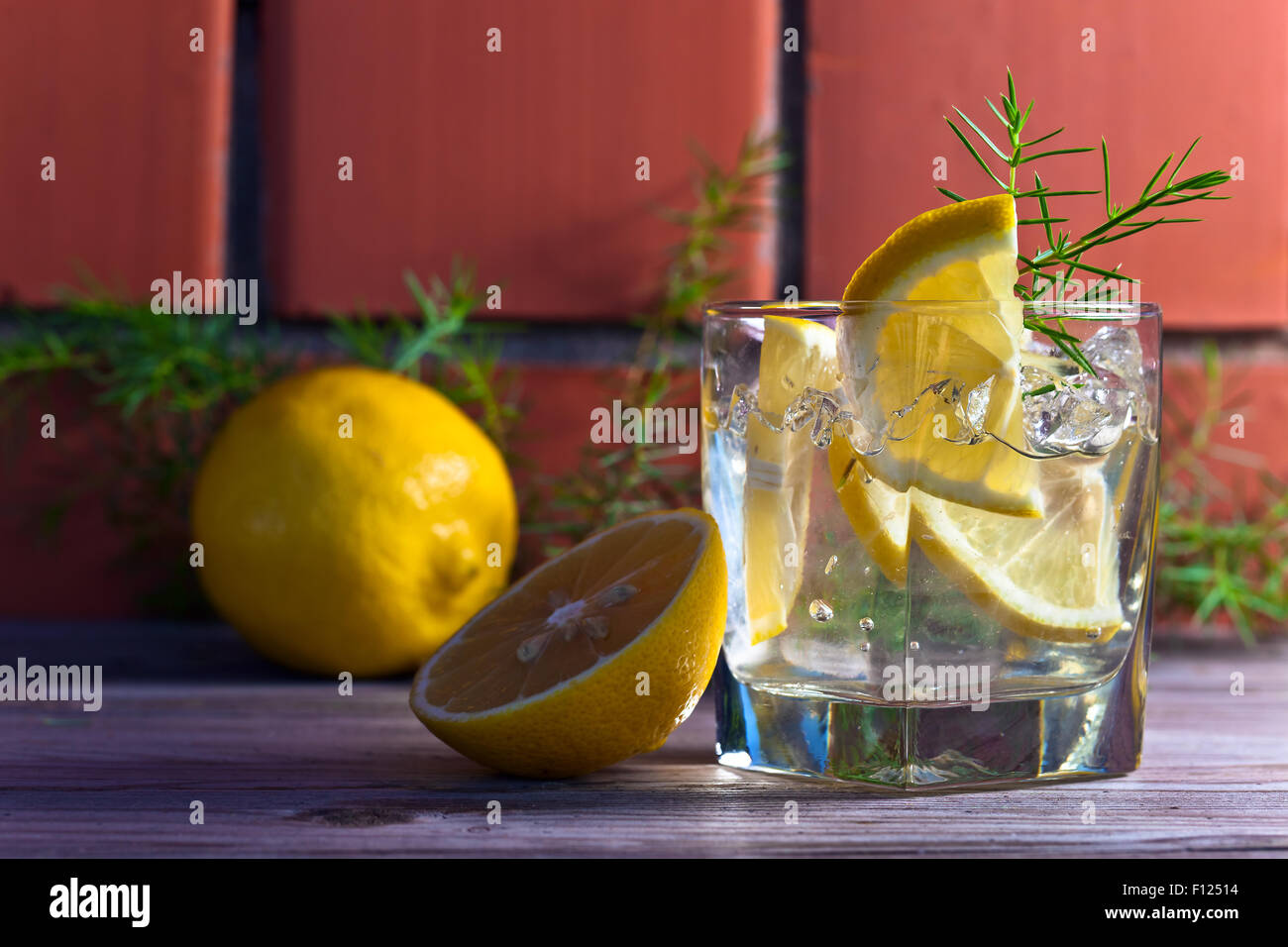 alcoholic drink with lemon and ice on a old wooden table Stock Photo ...