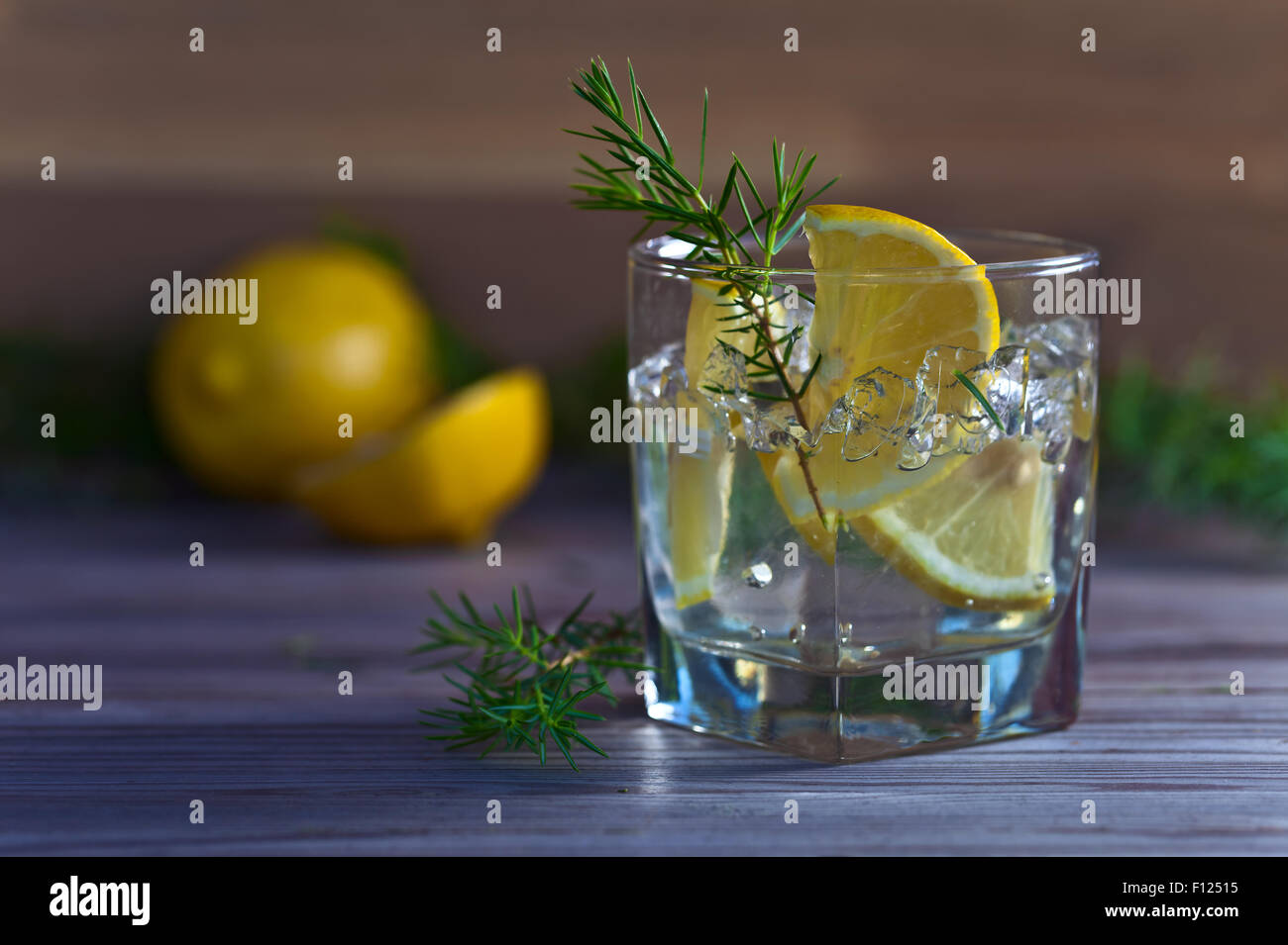 alcoholic drink with lemon and ice on a old wooden table Stock Photo ...