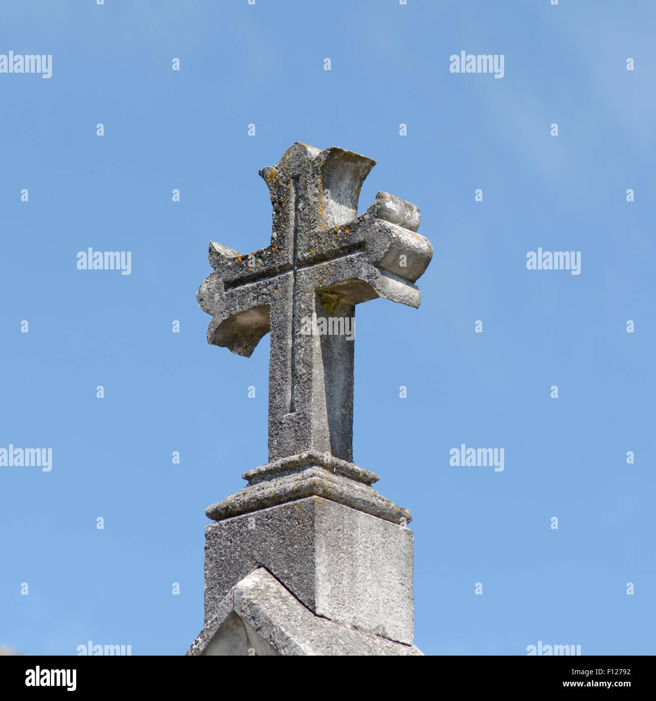 Stone Christian cross on grave in cemetery in St Thomas de Conac ...