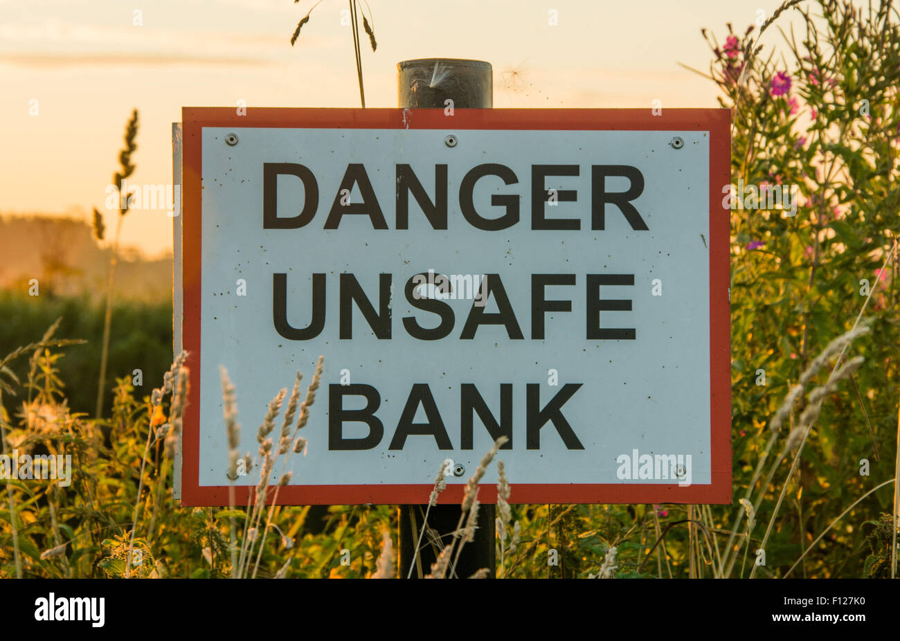 warning sign for unsafe river bank Stock Photo - Alamy