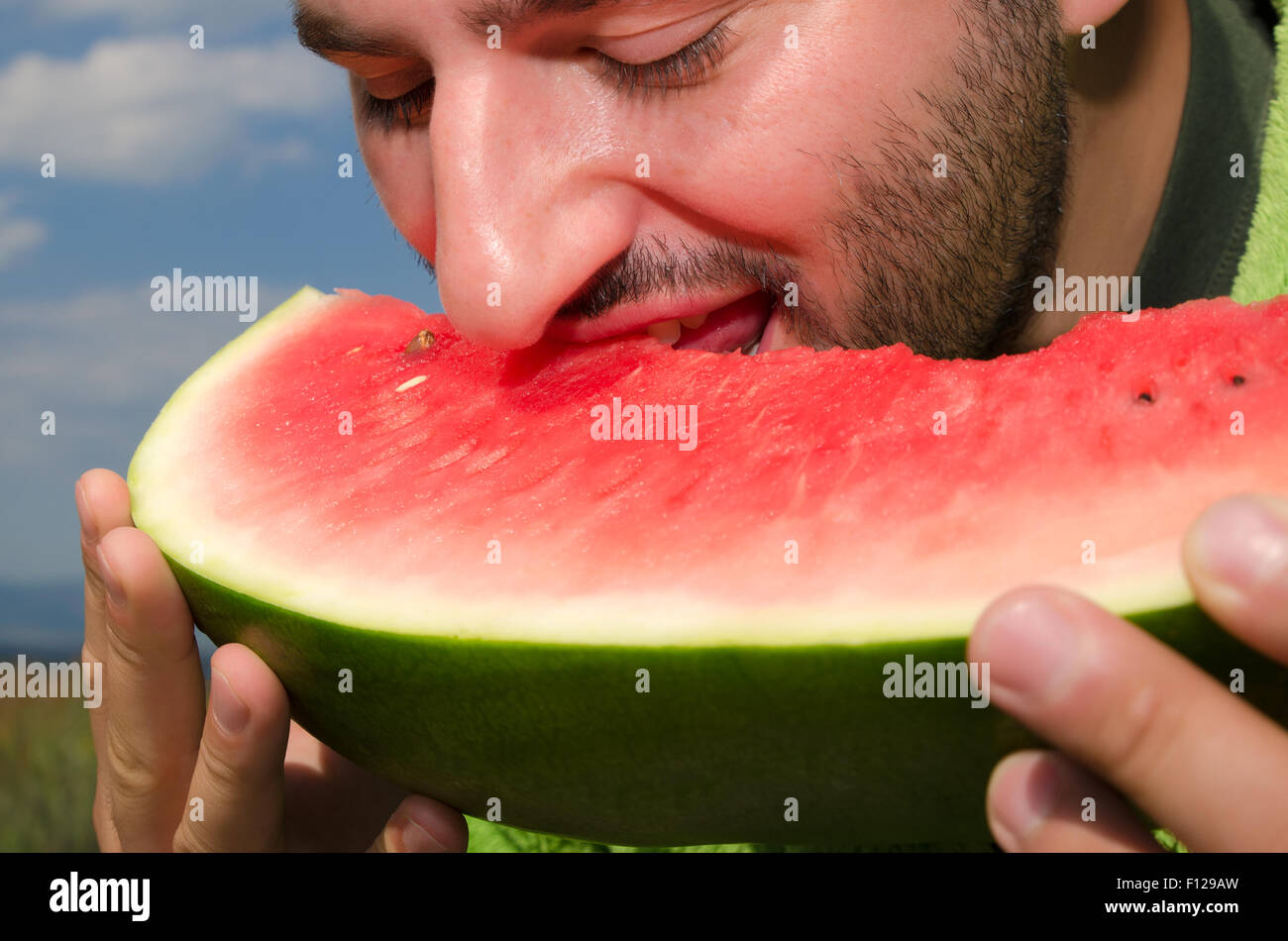Young man eating juicy watermelon in the Nature Stock Photo - Alamy