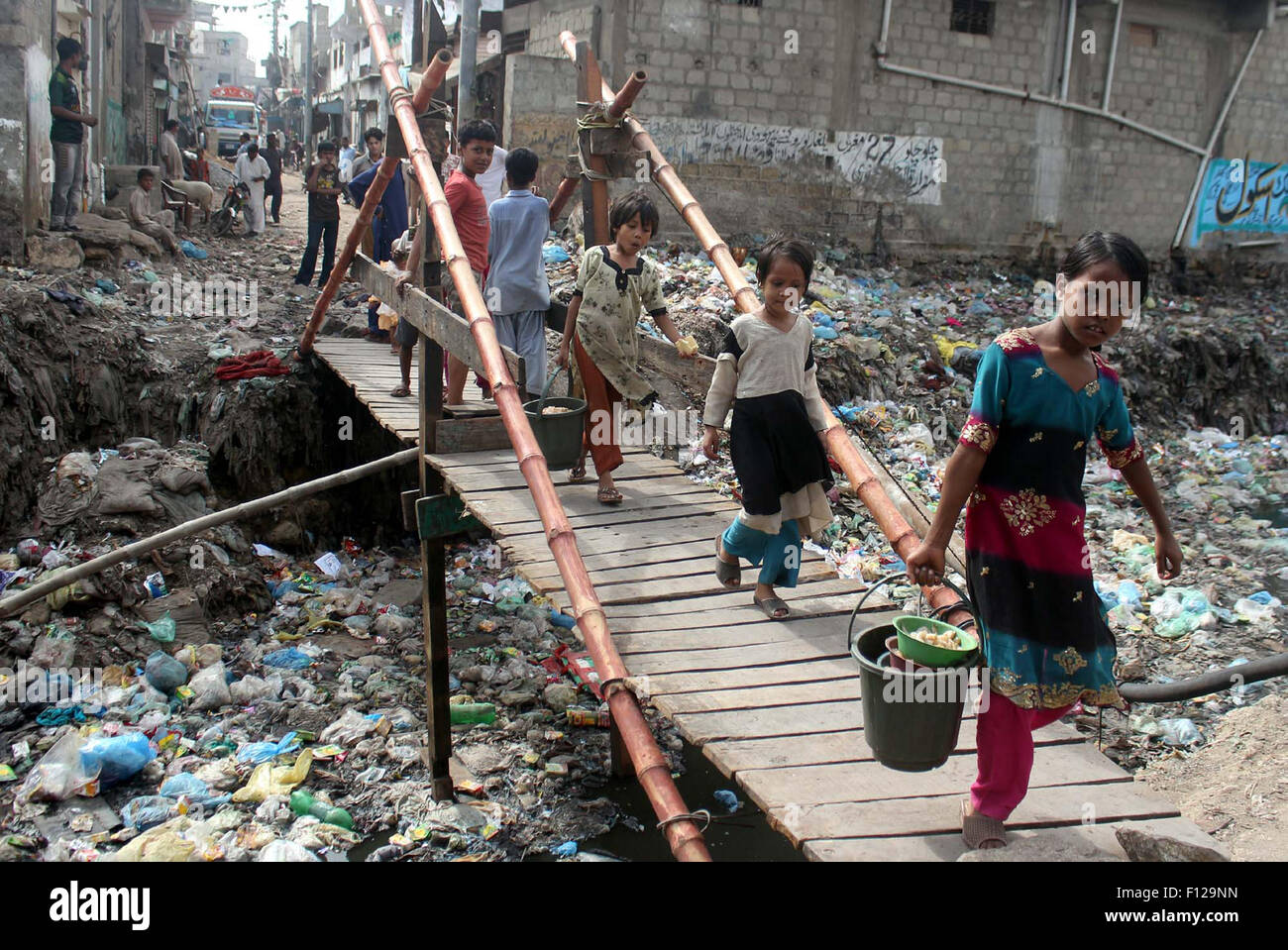 Children carrying drinking water pots are passing through the ...