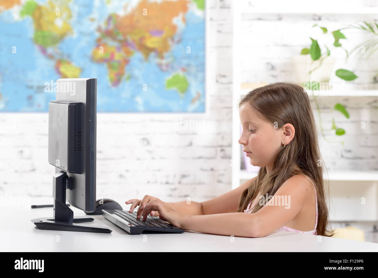 Schoolgirl in class using computer hi-res stock photography and images ...