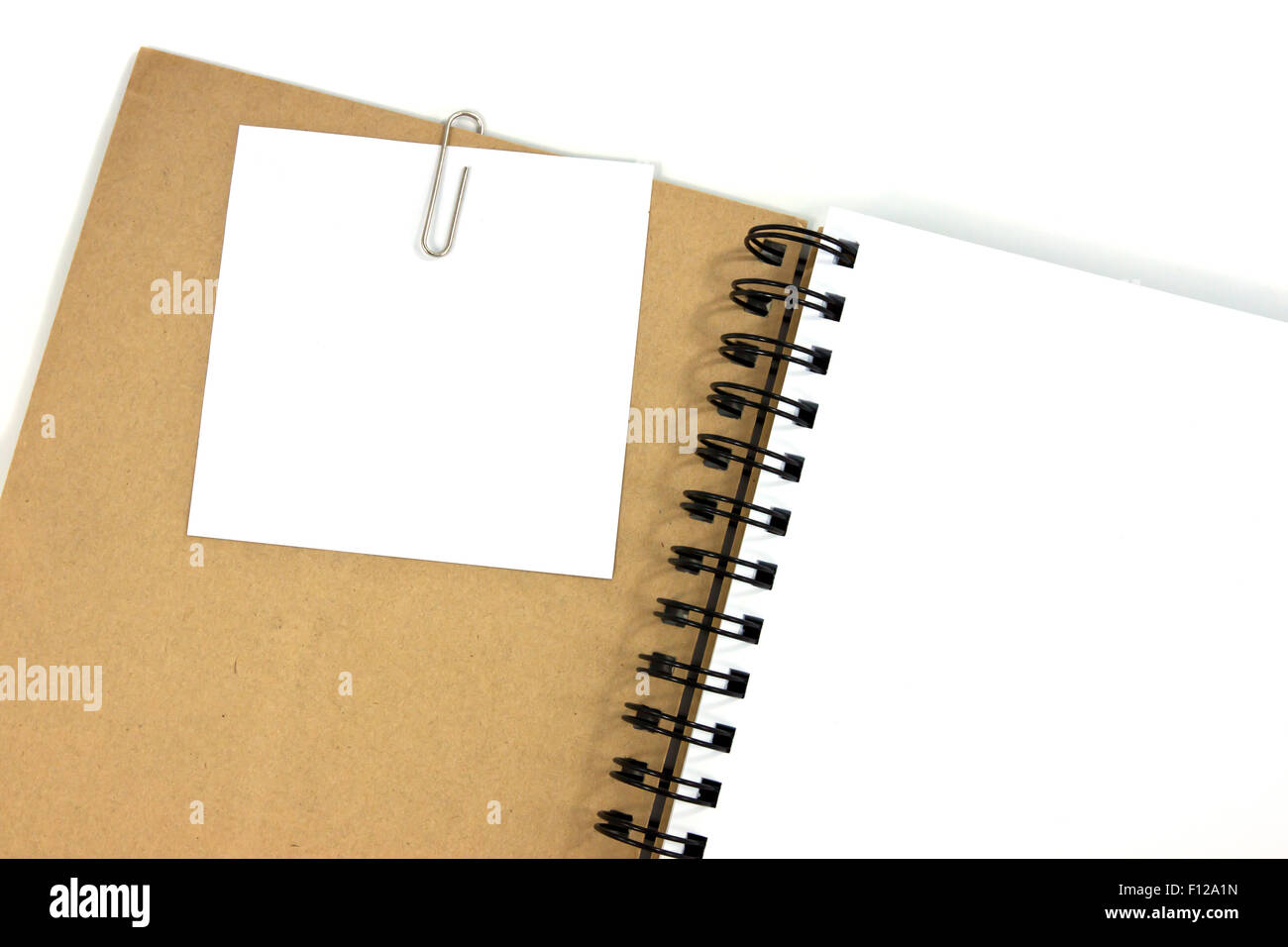 White note paper clip on brown cover note book Stock Photo - Alamy