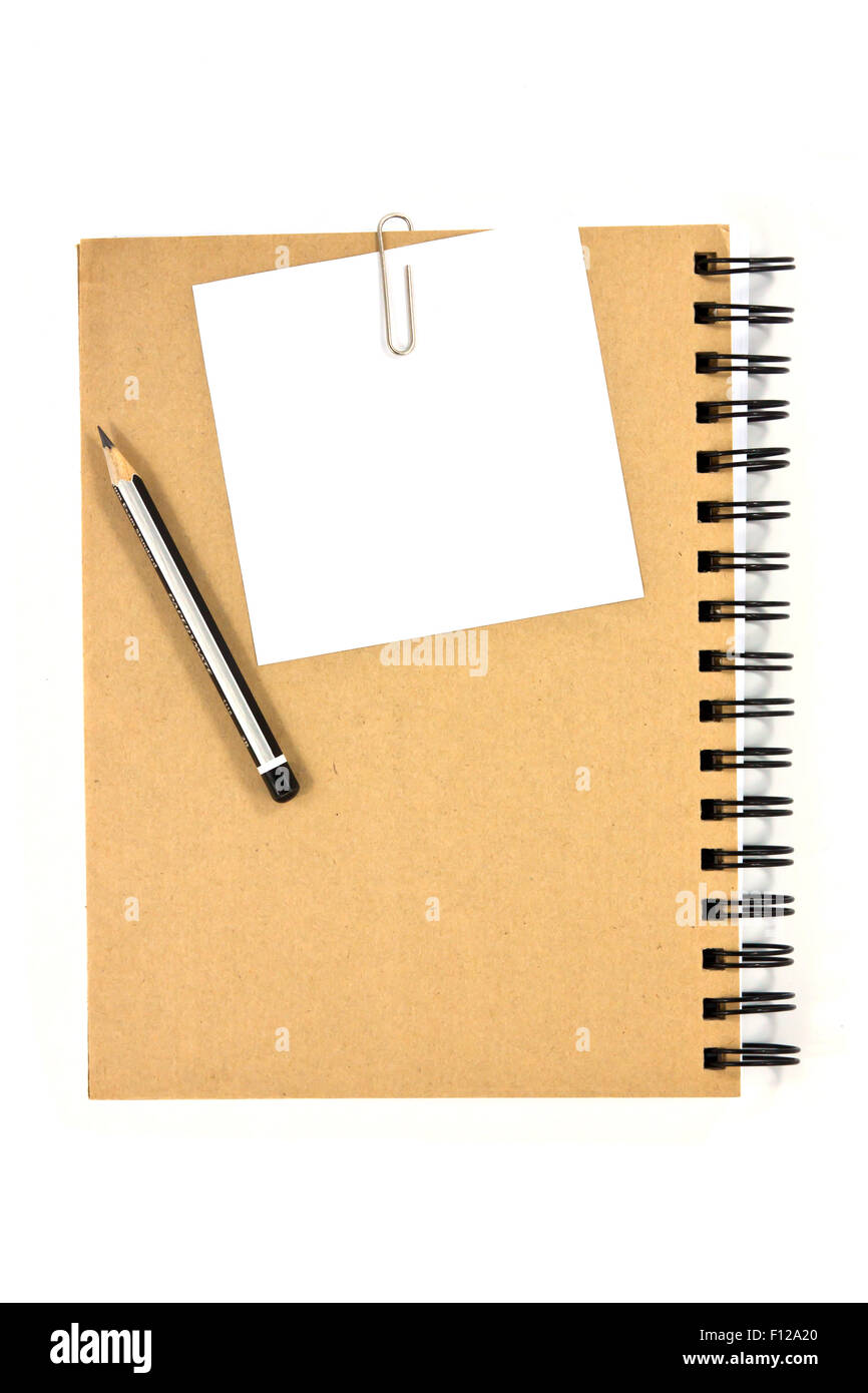White note paper clip on brown cover note book with pencil Stock Photo ...