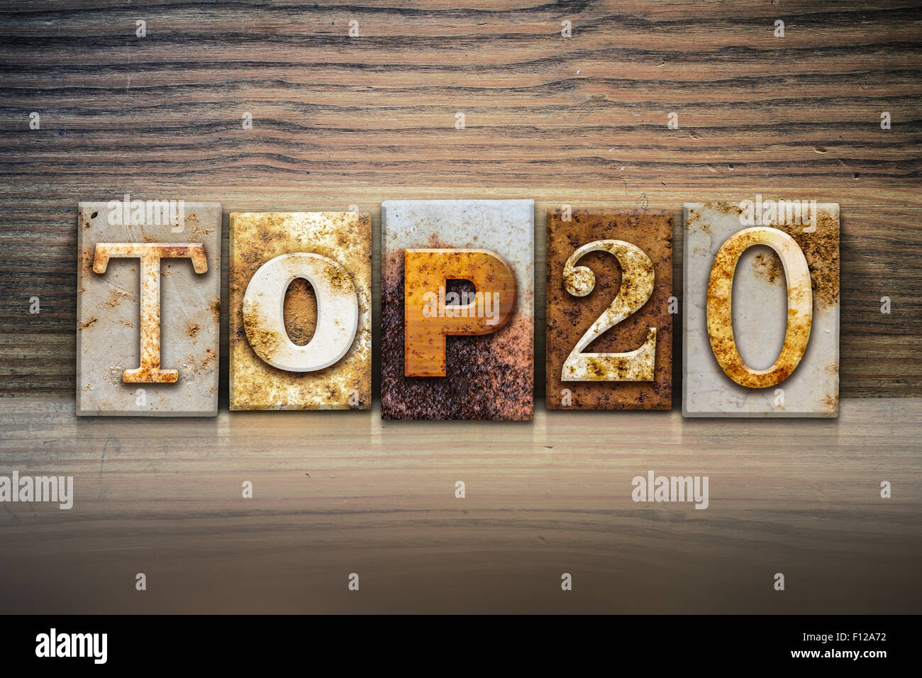 The word "TOP 20" written in rusty metal letterpress type sitting on a ...