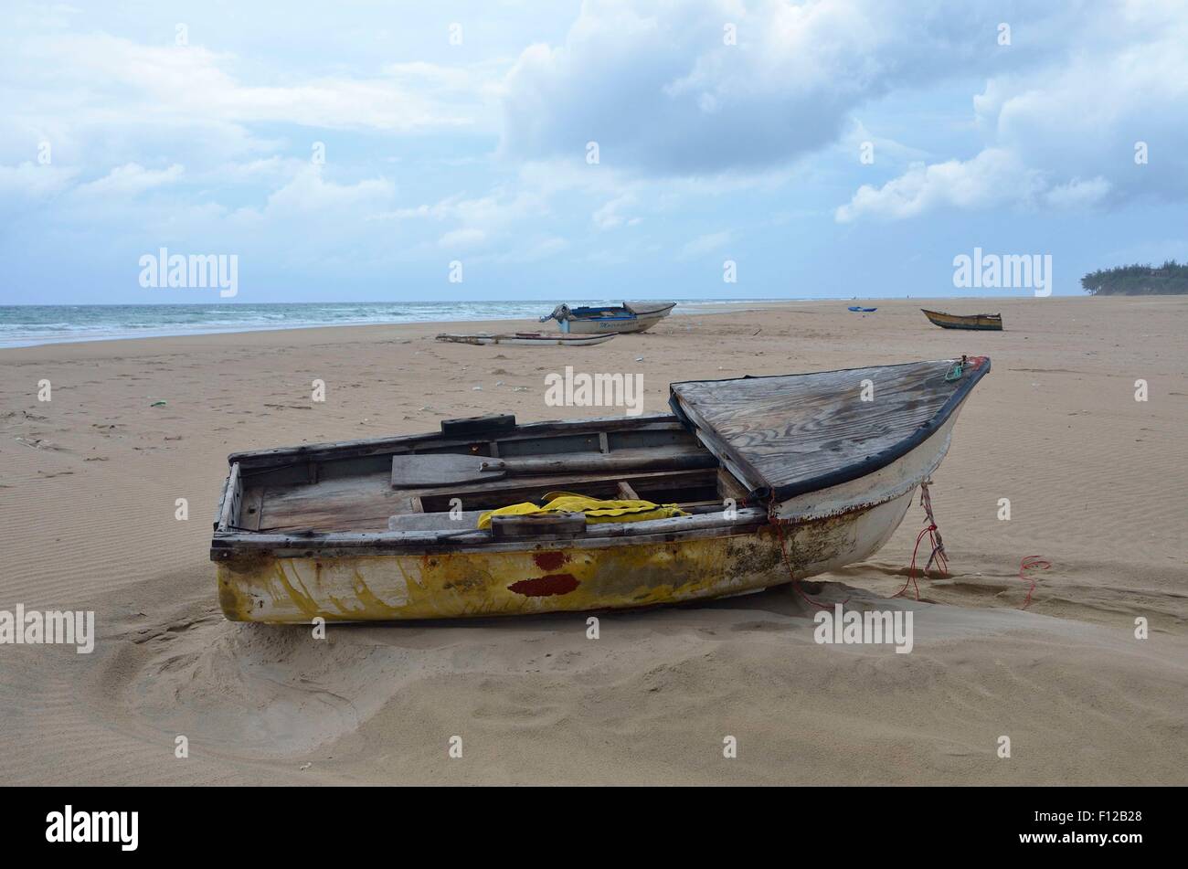 This old, unsafe fishing boat lying on the beach at Inhambane ...