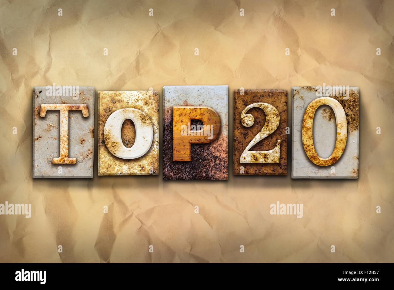 The word "TOP 20" written in rusty metal letterpress type on a crumbled ...