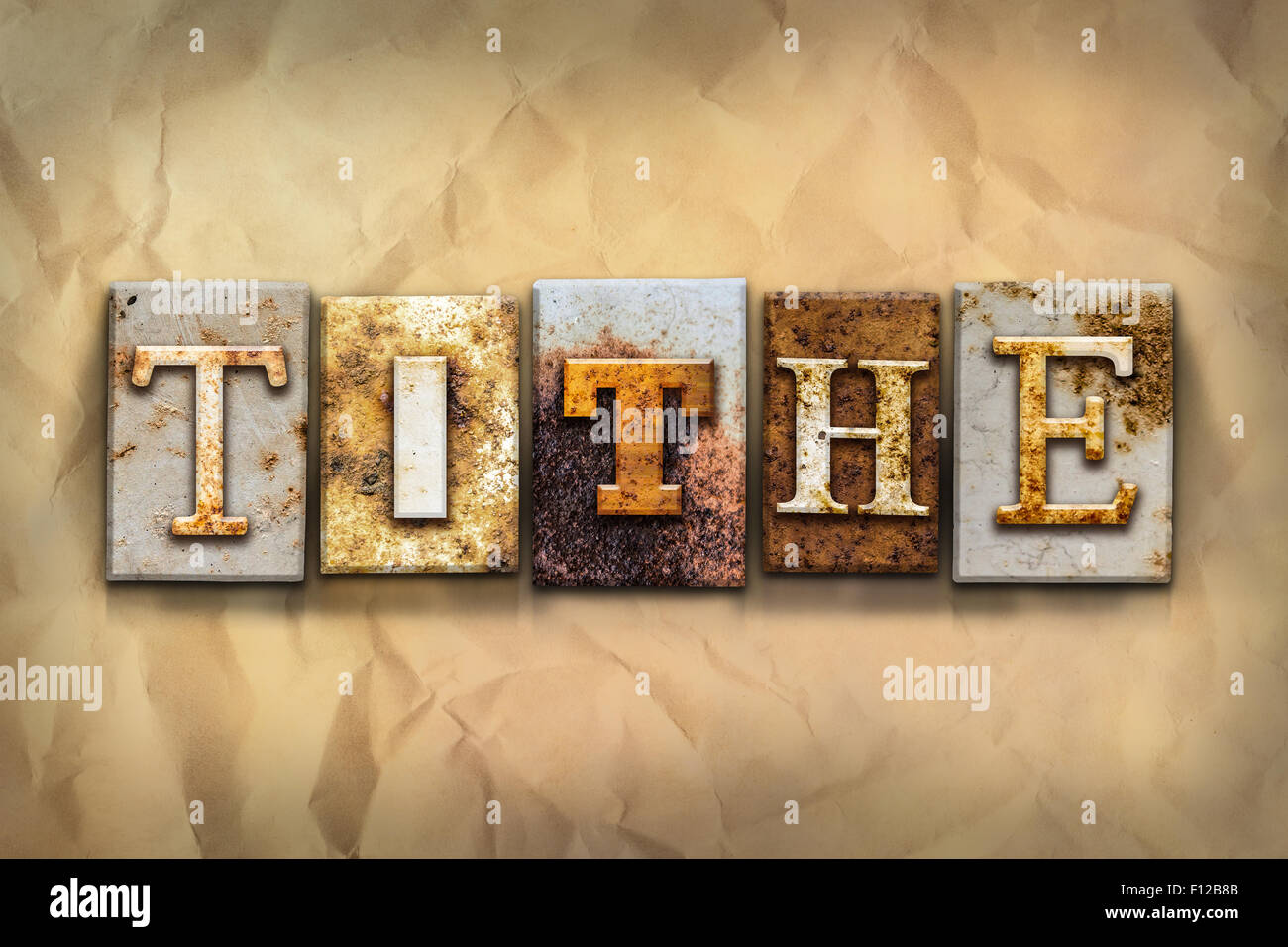 The word "TITHE" written in rusty metal letterpress type on a crumbled ...