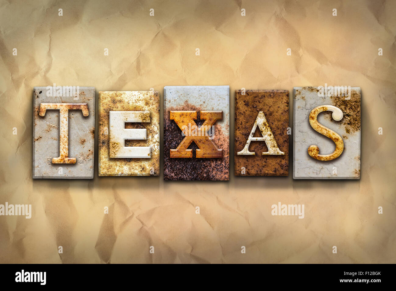 The word "TEXAS" written in rusty metal letterpress type on a crumbled ...