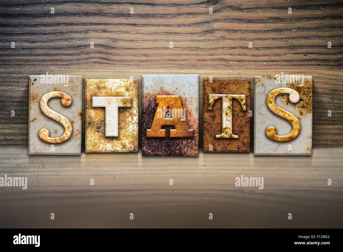 The word "STATS" written in rusty metal letterpress type sitting on a ...