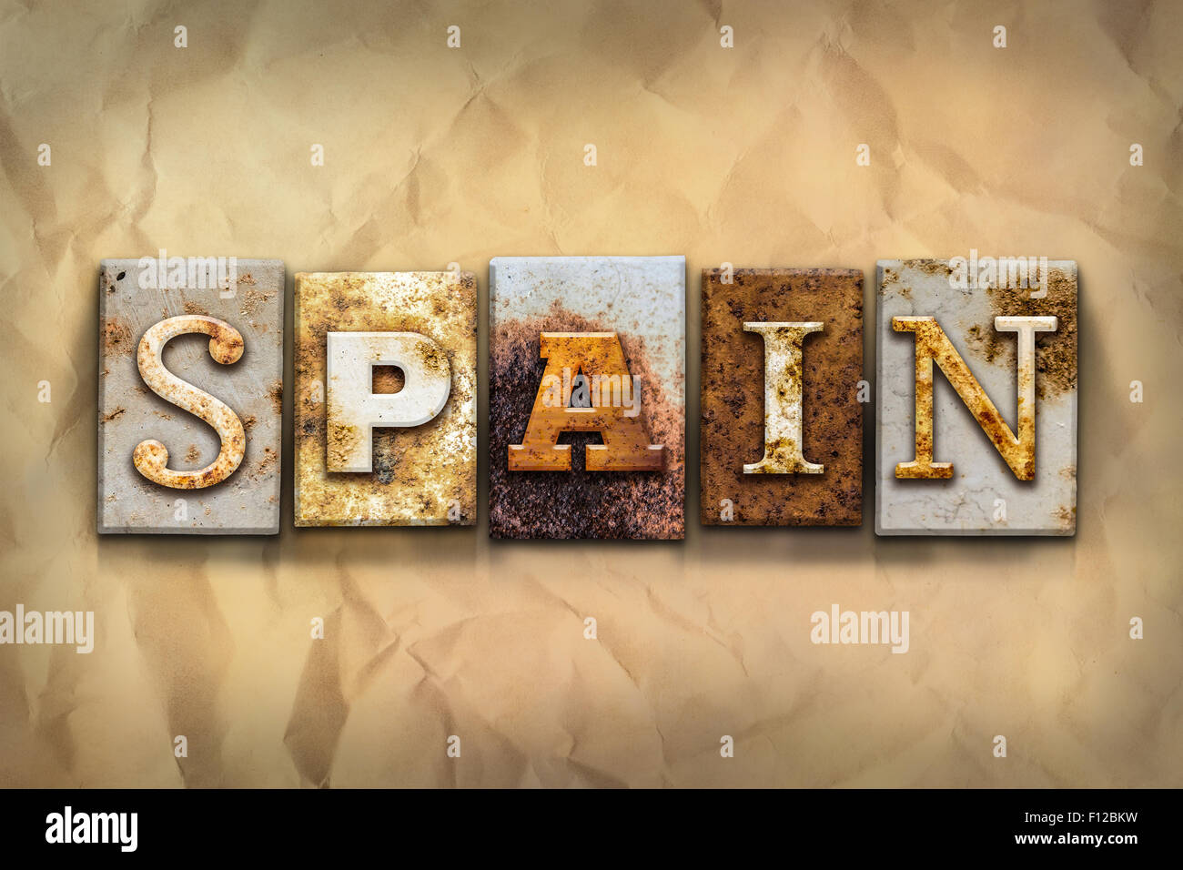 The word "SPAIN" written in rusty metal letterpress type on a crumbled ...