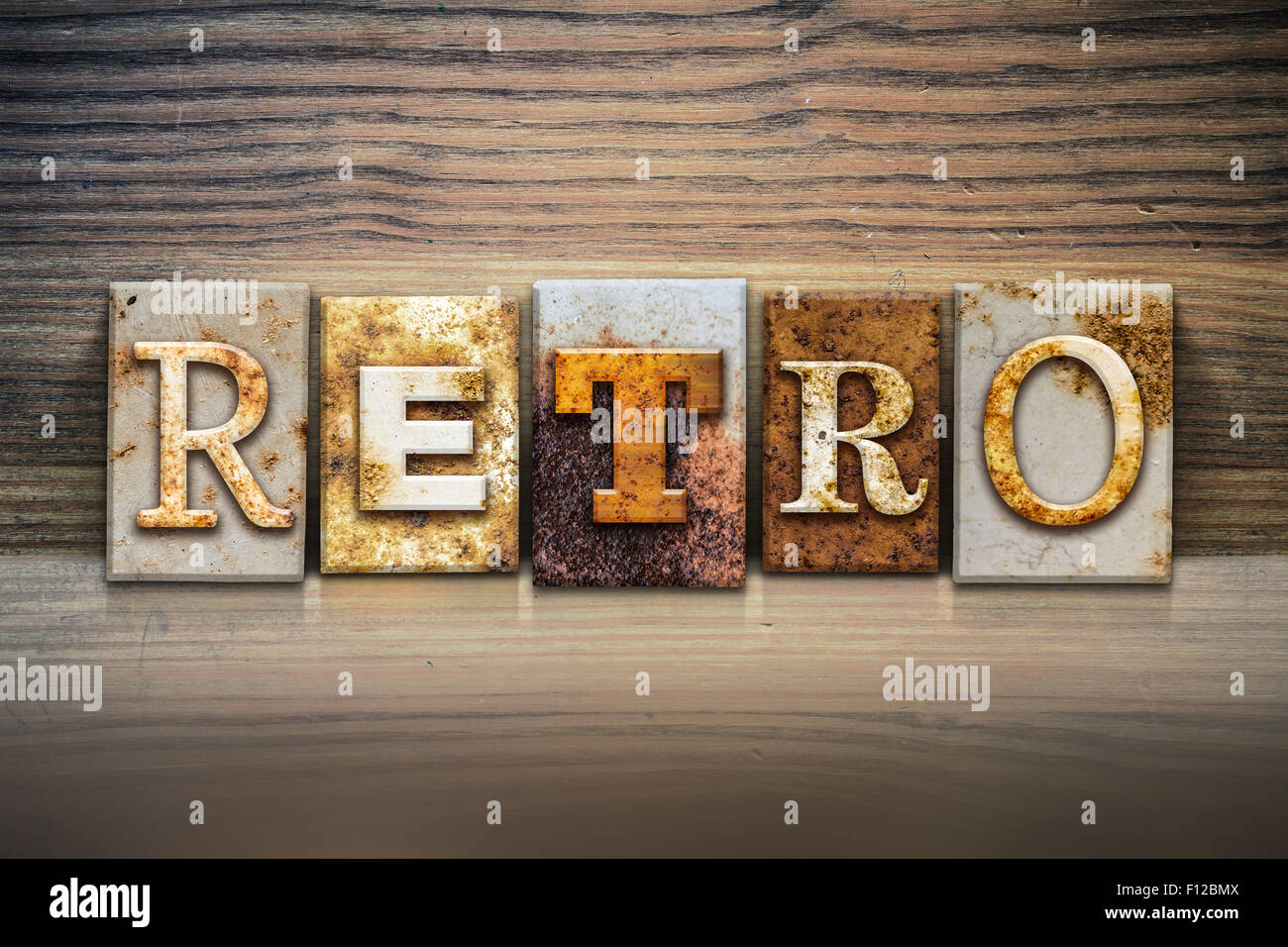 The word "RETRO" written in rusty metal letterpress type sitting on a ...