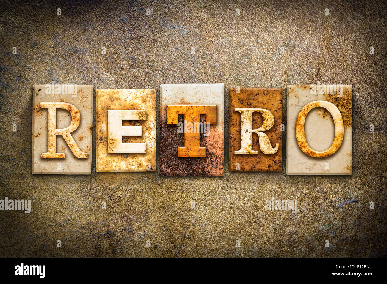 The word "RETRO" written in rusty metal letterpress type on an old aged ...