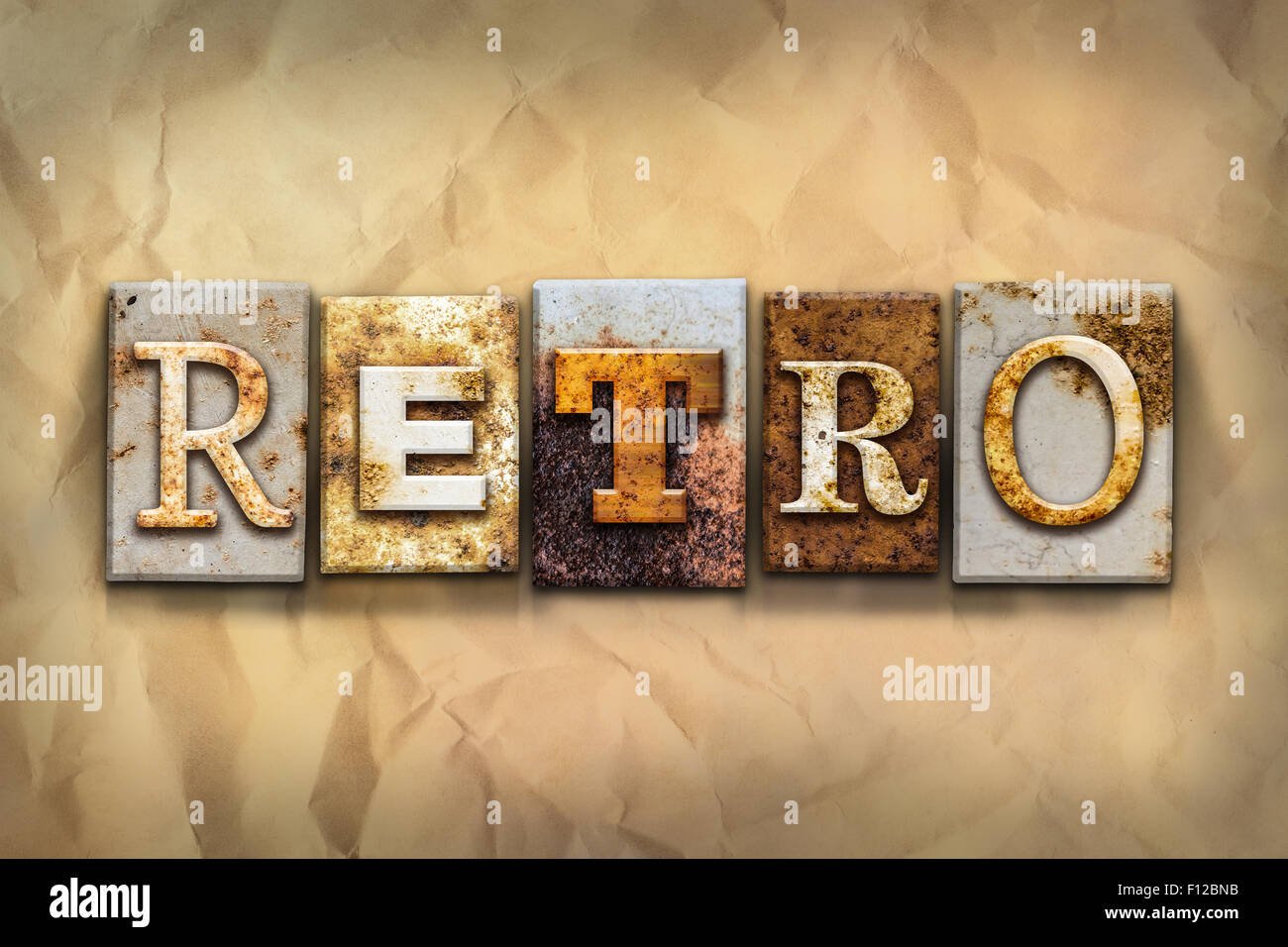 The word "RETRO" written in rusty metal letterpress type on a crumbled ...