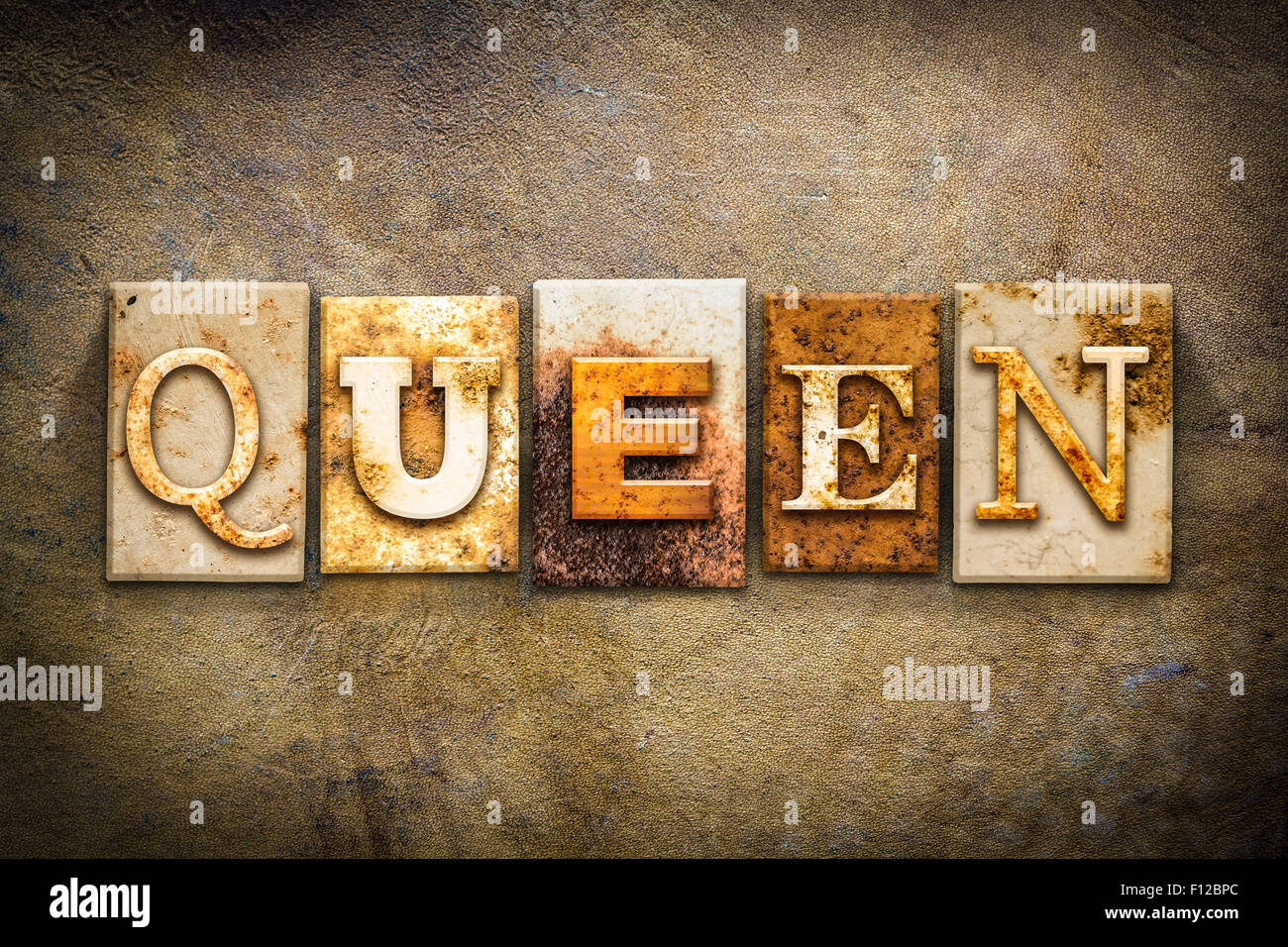 The word "QUEEN" written in rusty metal letterpress type on an old aged ...
