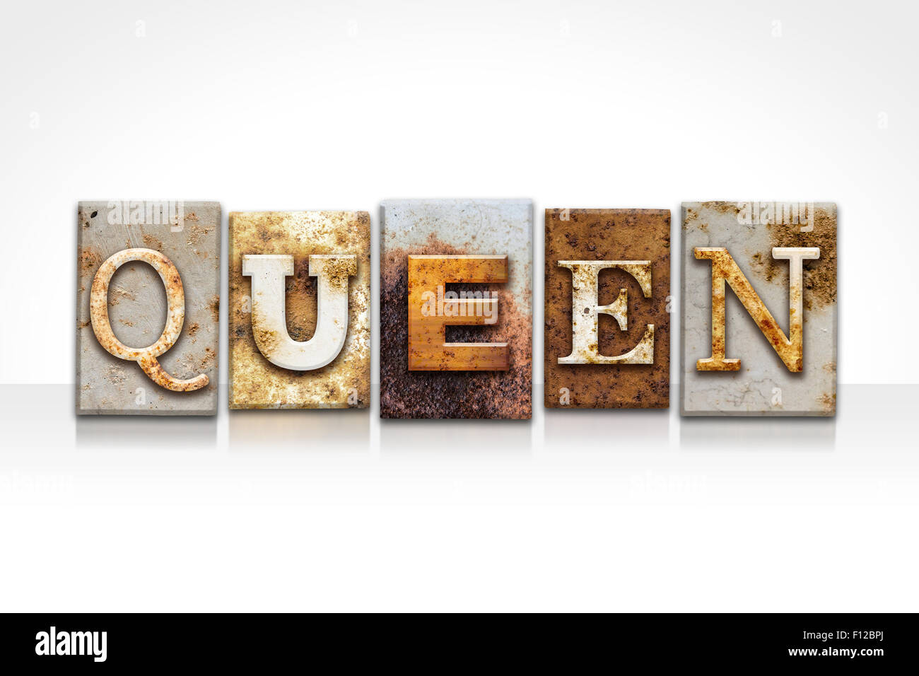 The word "QUEEN" written in rusty metal letterpress type isolated on a ...