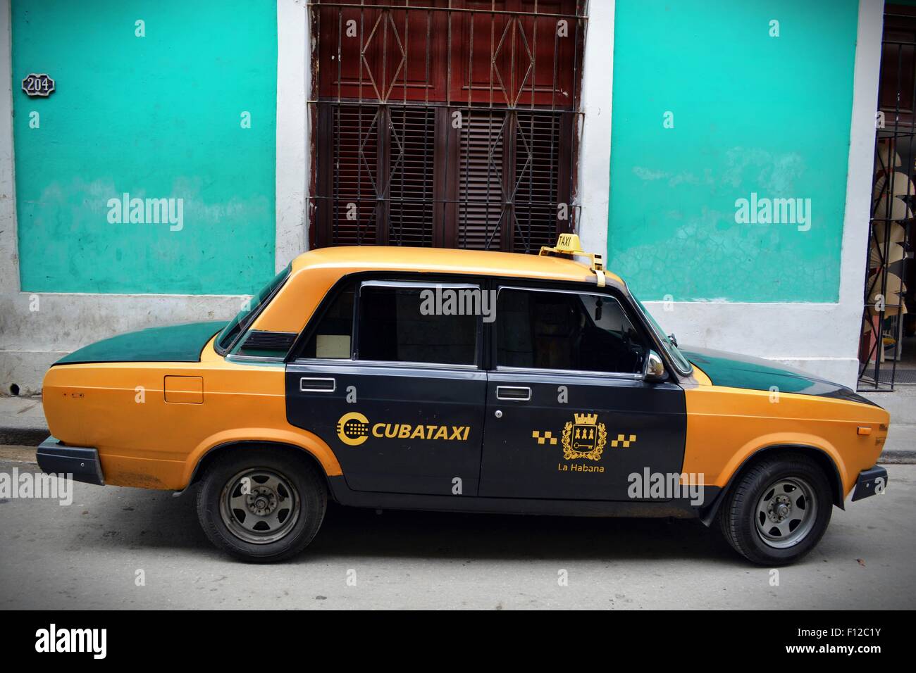 yellow Cubana taxi cab parked in a quiet street in Havana, Cuba Stock ...