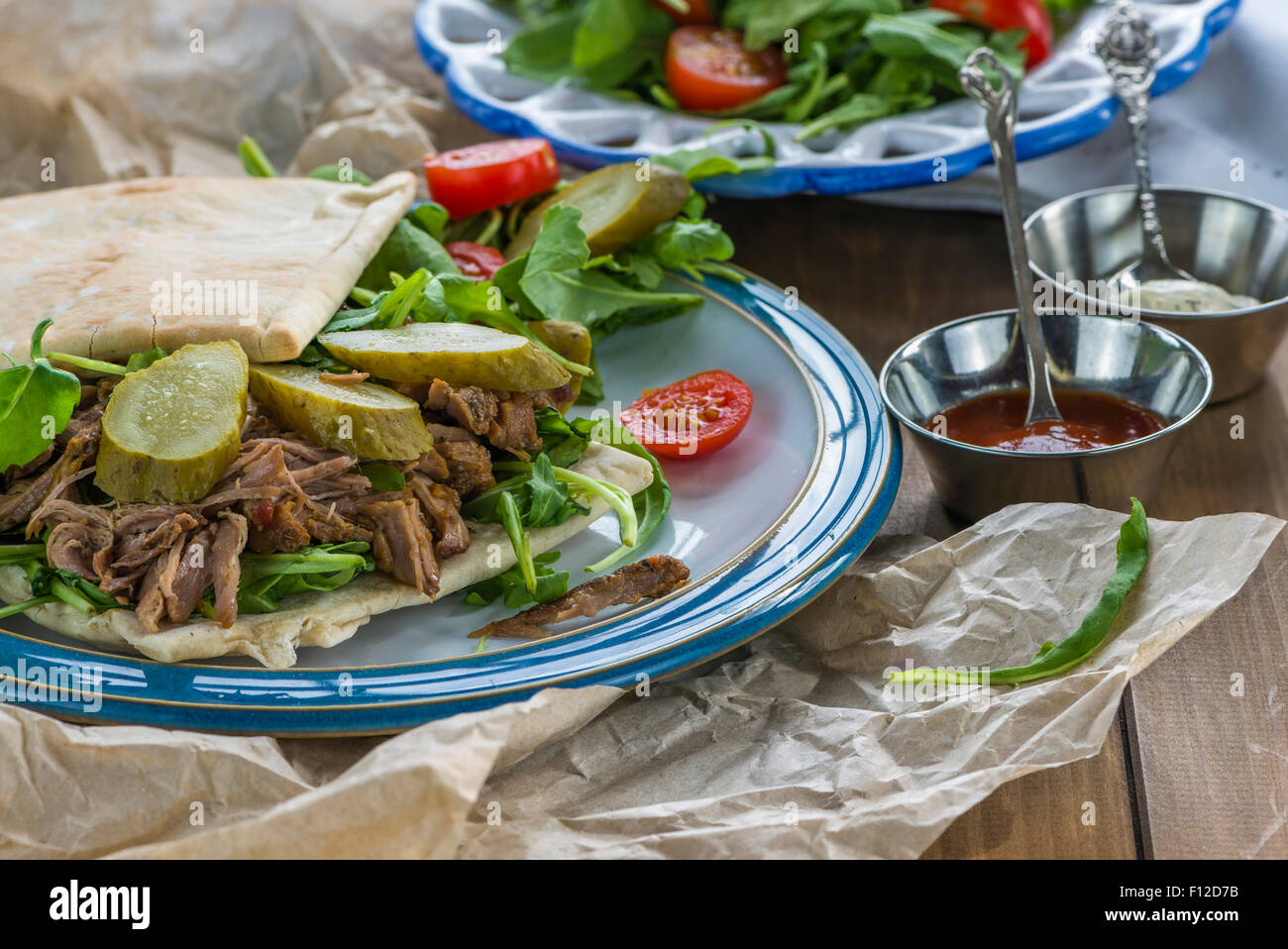 Pulled lamb with fresh rocket salad and pitta bread Stock Photo - Alamy