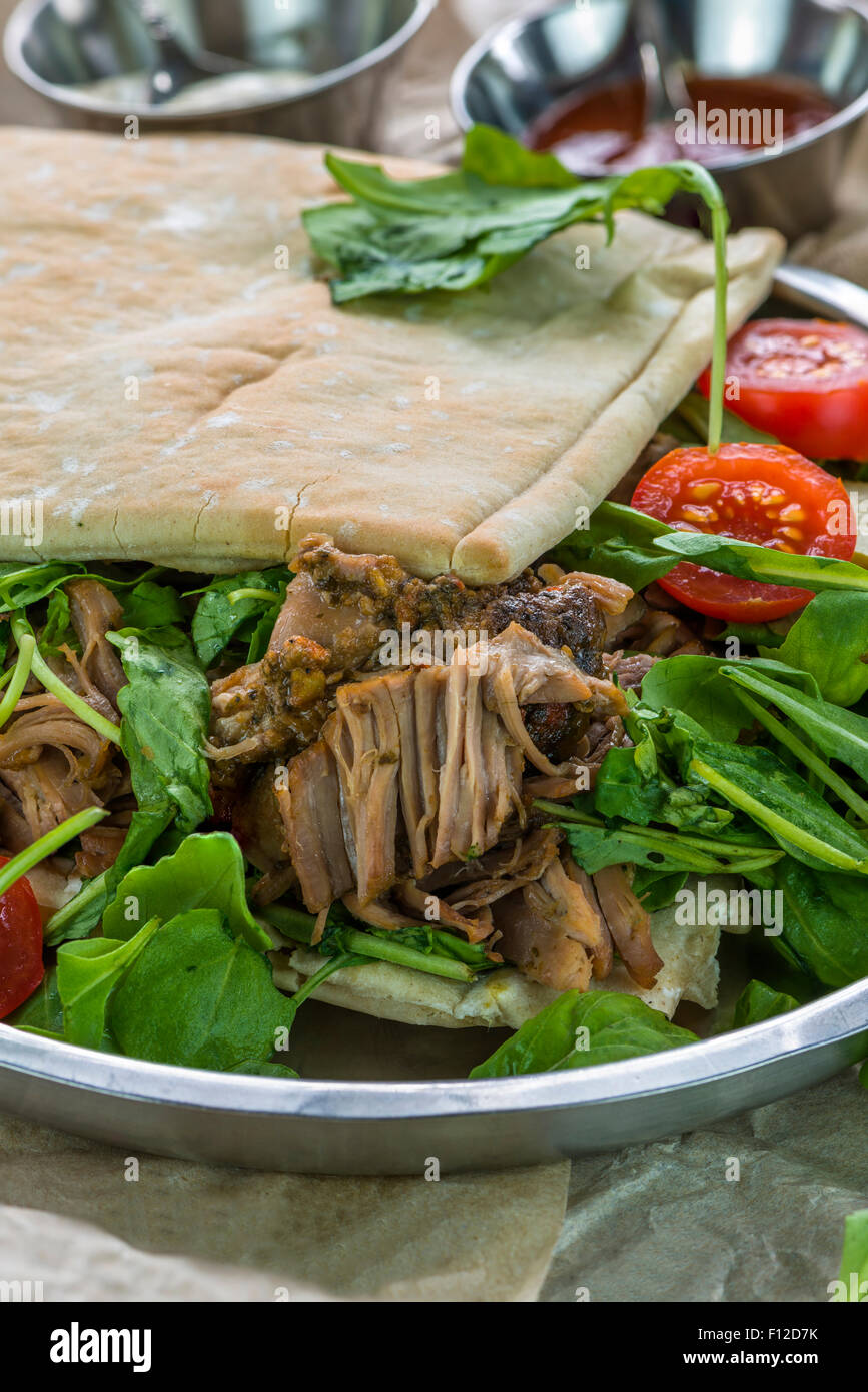 Pulled lamb with fresh rocket salad and pitta bread Stock Photo - Alamy