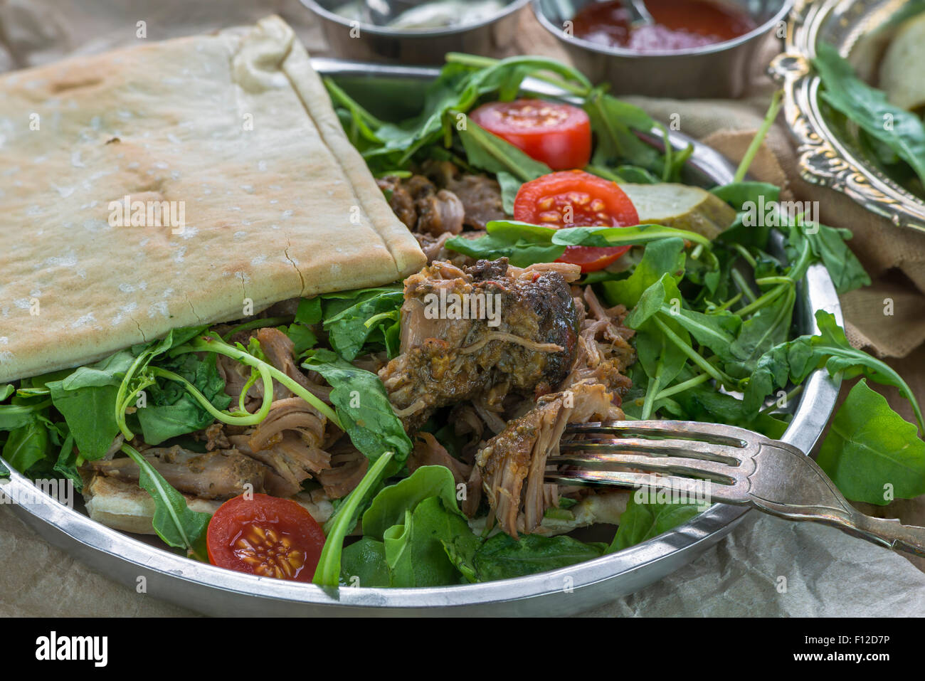 Pulled lamb with fresh rocket salad and pitta bread Stock Photo - Alamy
