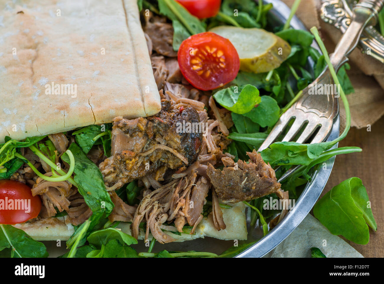 Pulled lamb with fresh rocket salad and pitta bread Stock Photo - Alamy