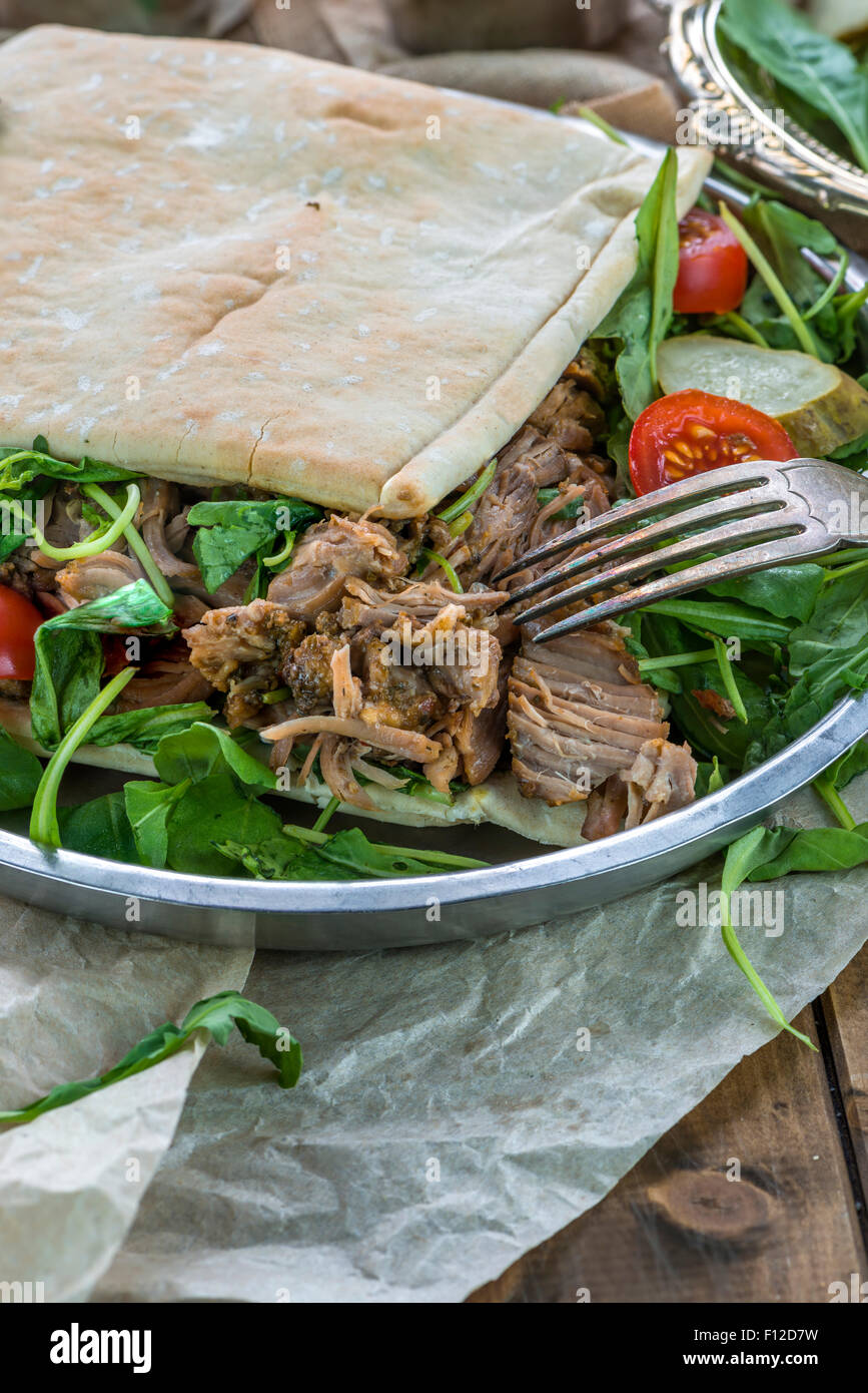 Pulled lamb with fresh rocket salad and pitta bread Stock Photo - Alamy