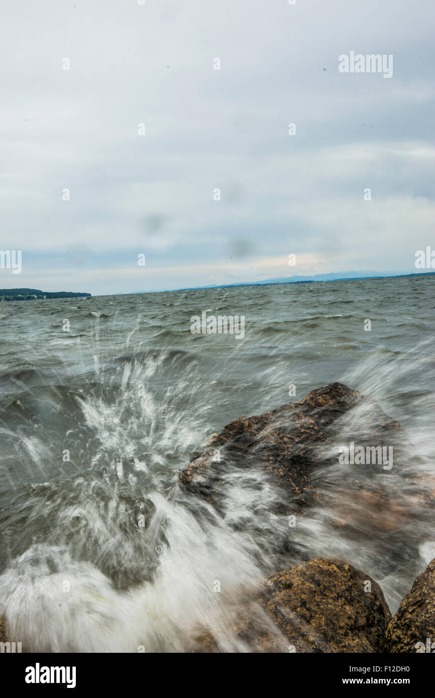 Water splashing against some rocks along a coast Stock Photo - Alamy