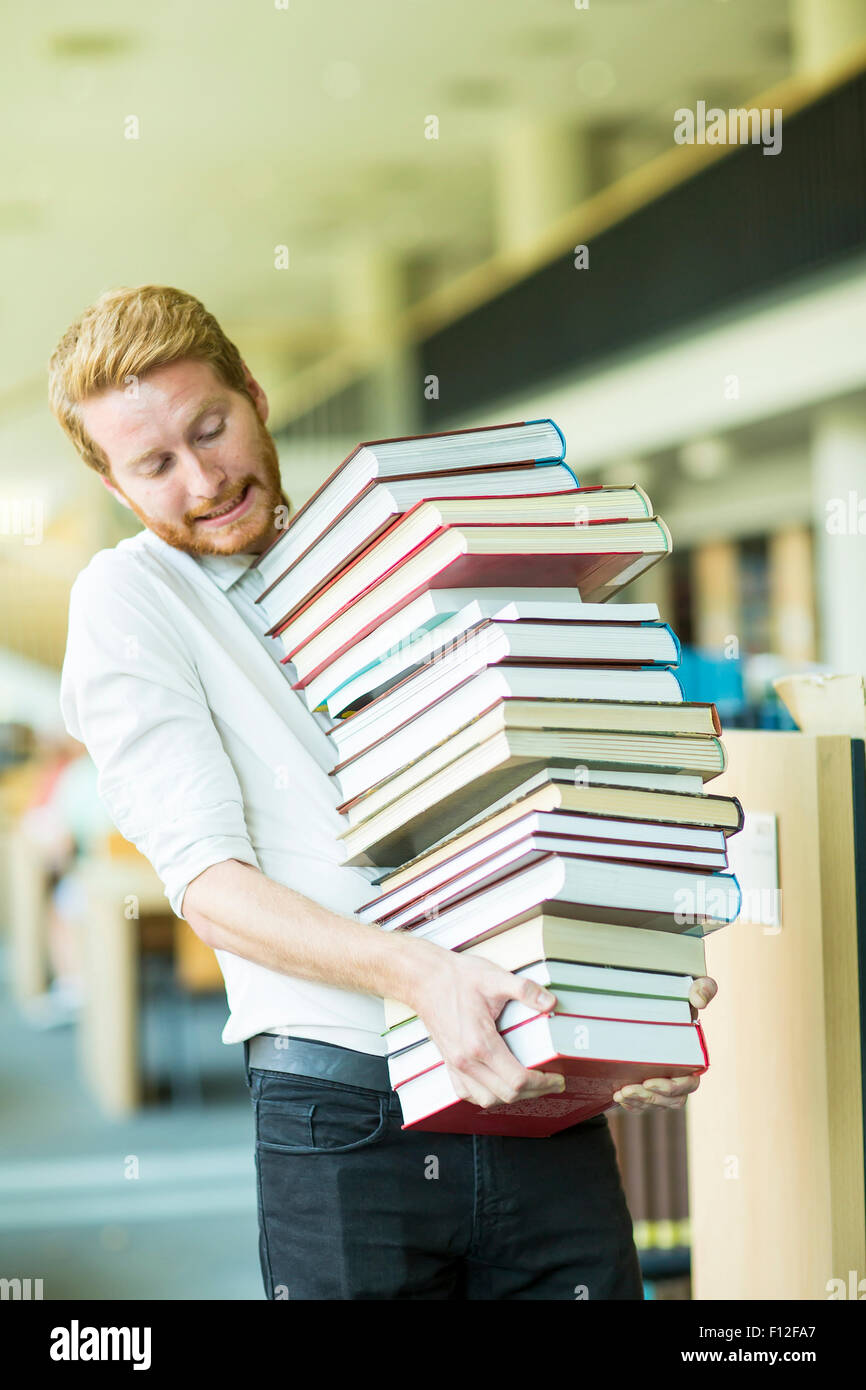 Young man in the library Stock Photo - Alamy