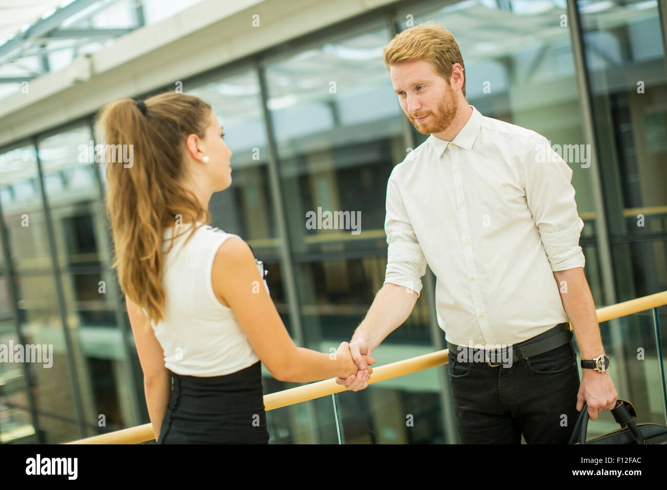 Young people handshaking Stock Photo - Alamy