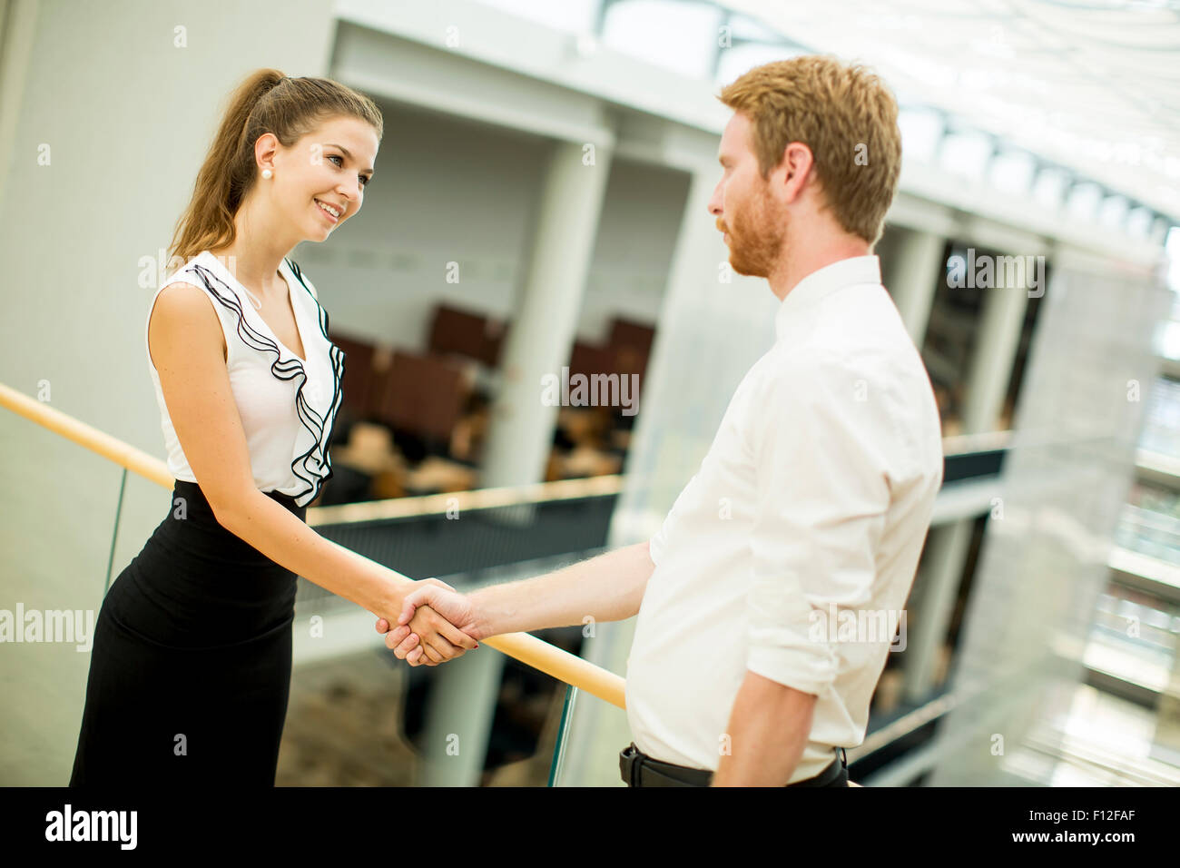 Young people handshaking Stock Photo - Alamy