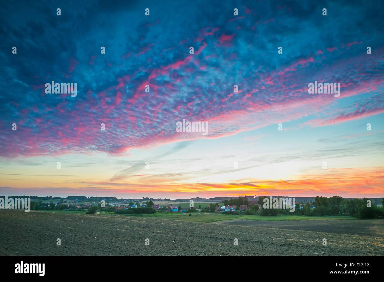 Beautiful and spectacular sunset sky over calm countryside. Polish ...