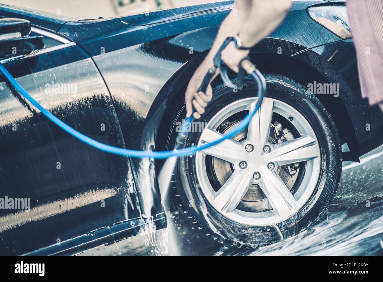 Self Car Washing. Cleaning Wheels Using High Pressure Water Stock Photo ...