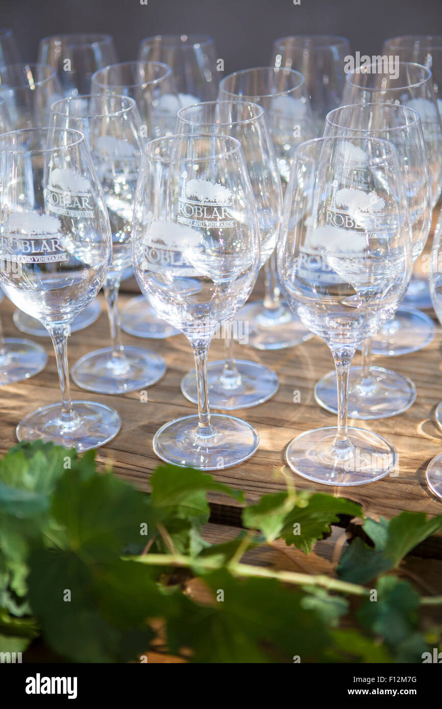 wine glasses are set out for a Members’ Dinner at Roblar Winery, Santa ...