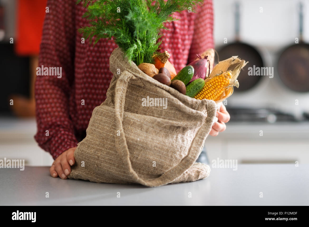 A burlap sac is bursting forth with a selection of autumn vegetables ...